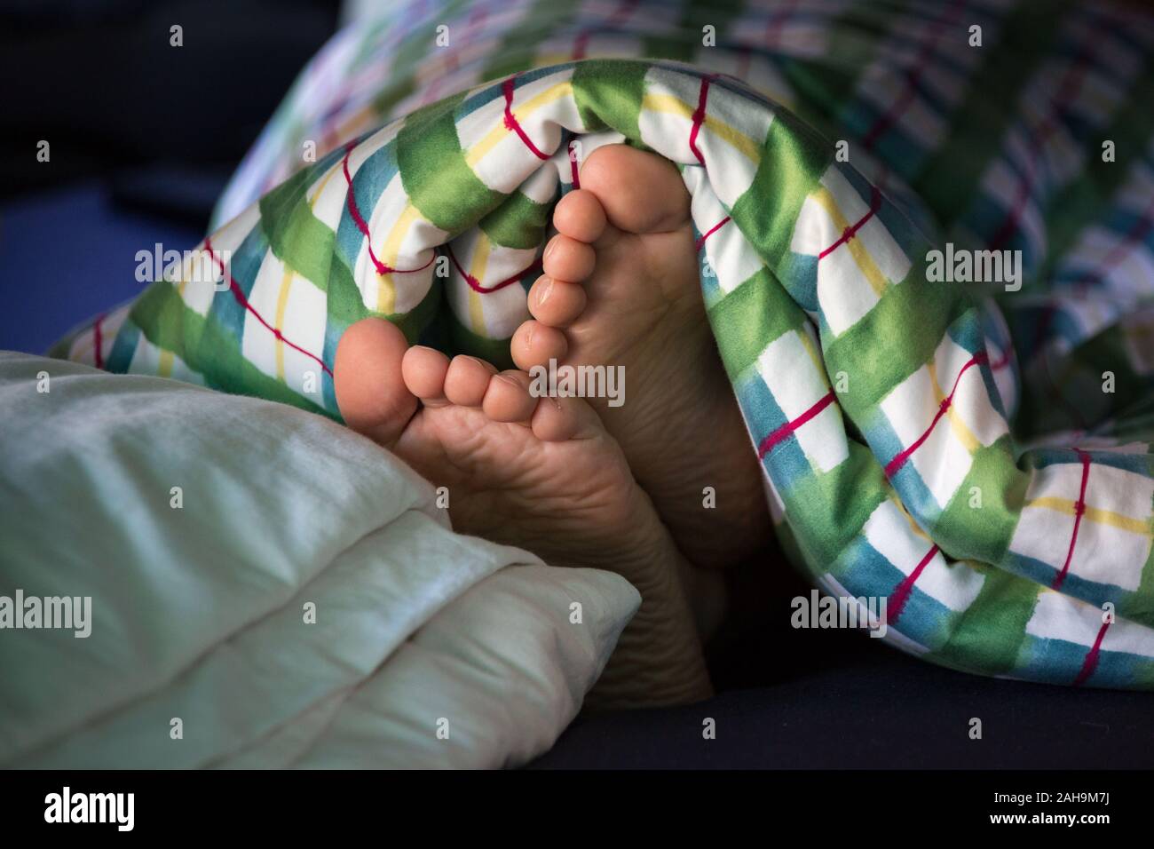 Feet Under Blanket High Resolution Stock Photography and Images - Alamy