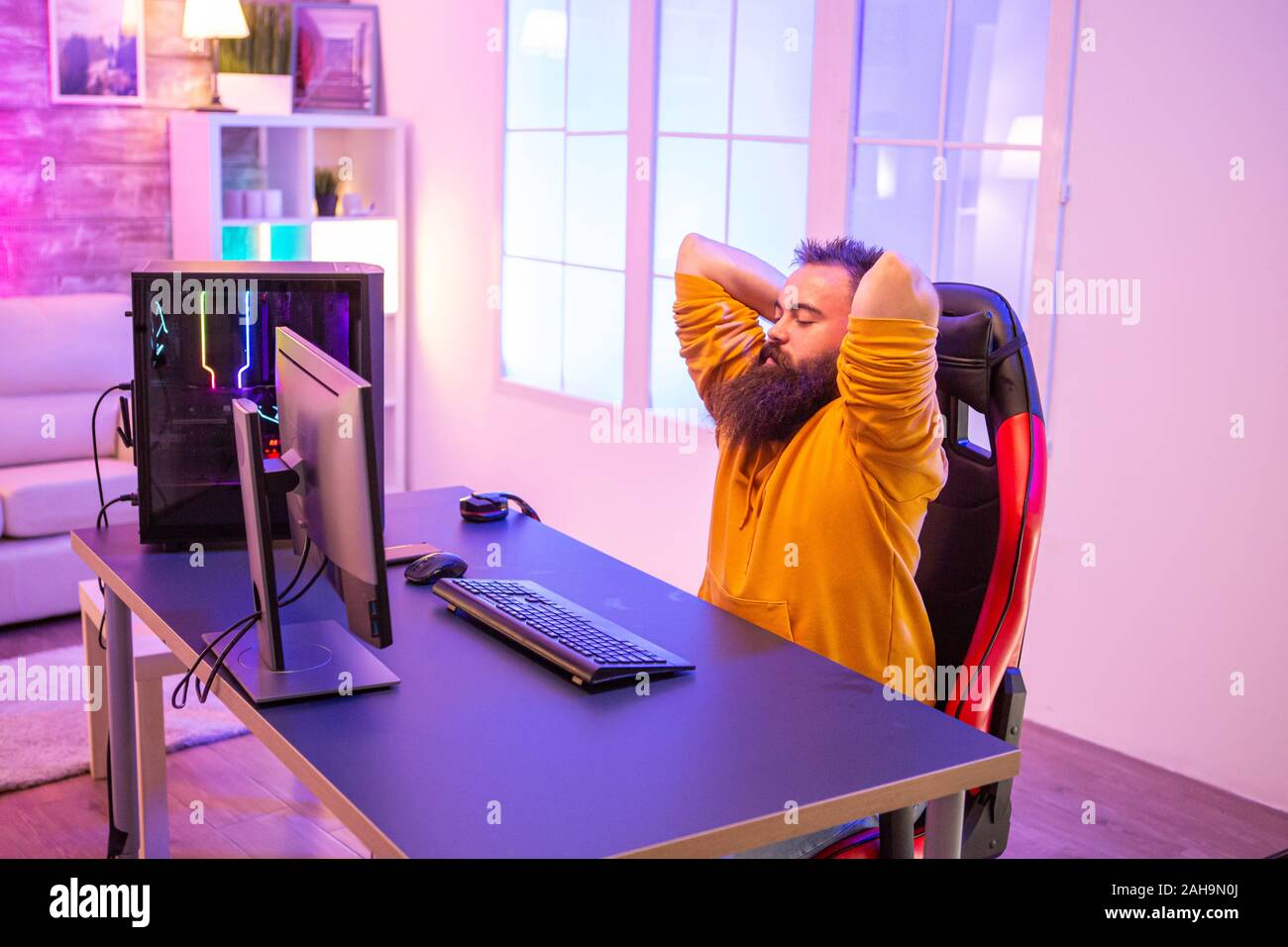 Caucasian bearded gamer preaparing himself for a sesion of video games ...