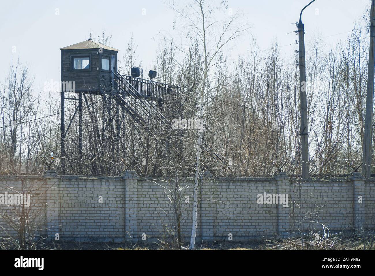 Watchtower at the fence with barbed wire. Soft focus Stock Photo - Alamy