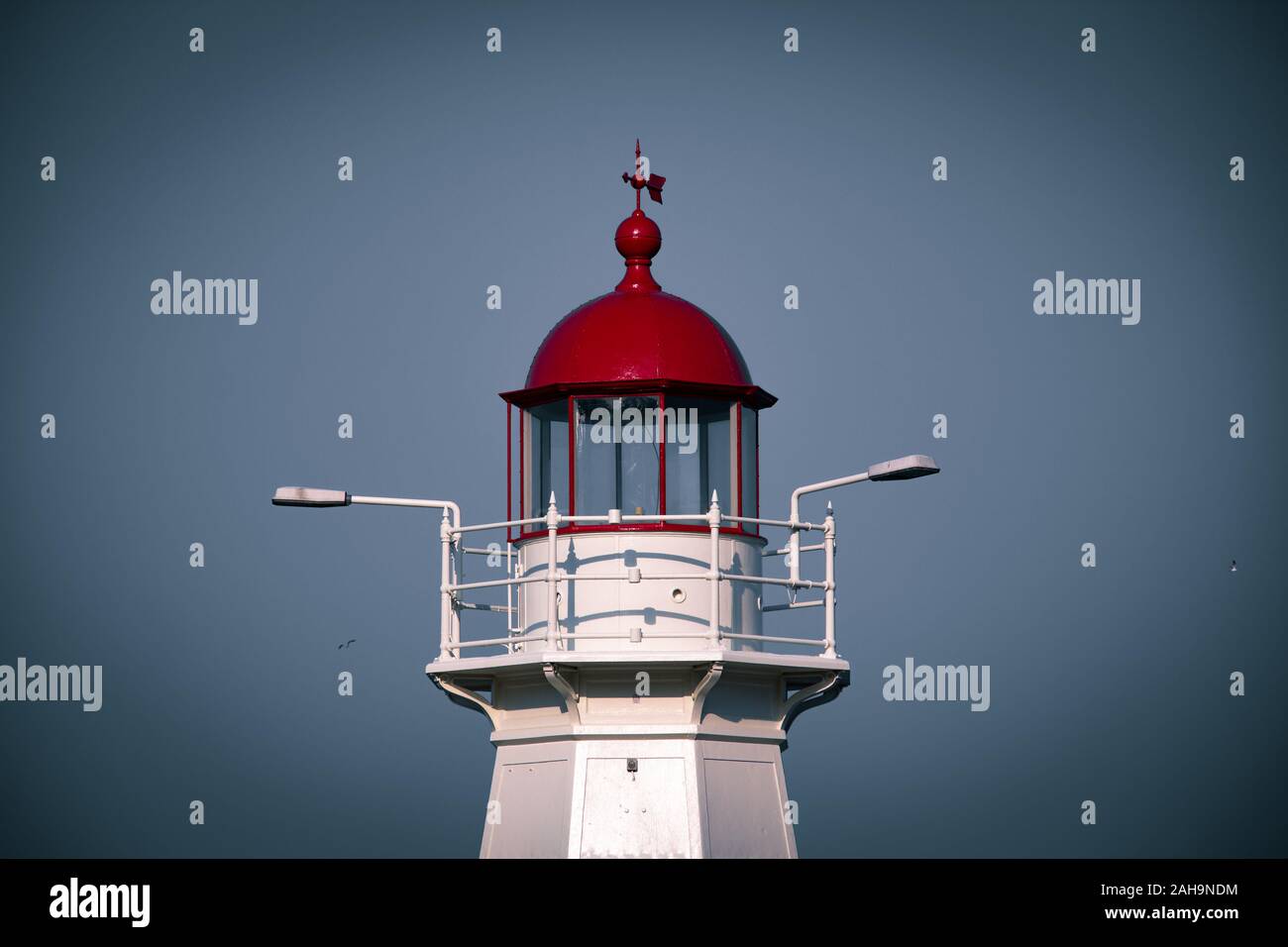 A generic lighthouse in white and red in the harbor of Malmö, Sweden ...