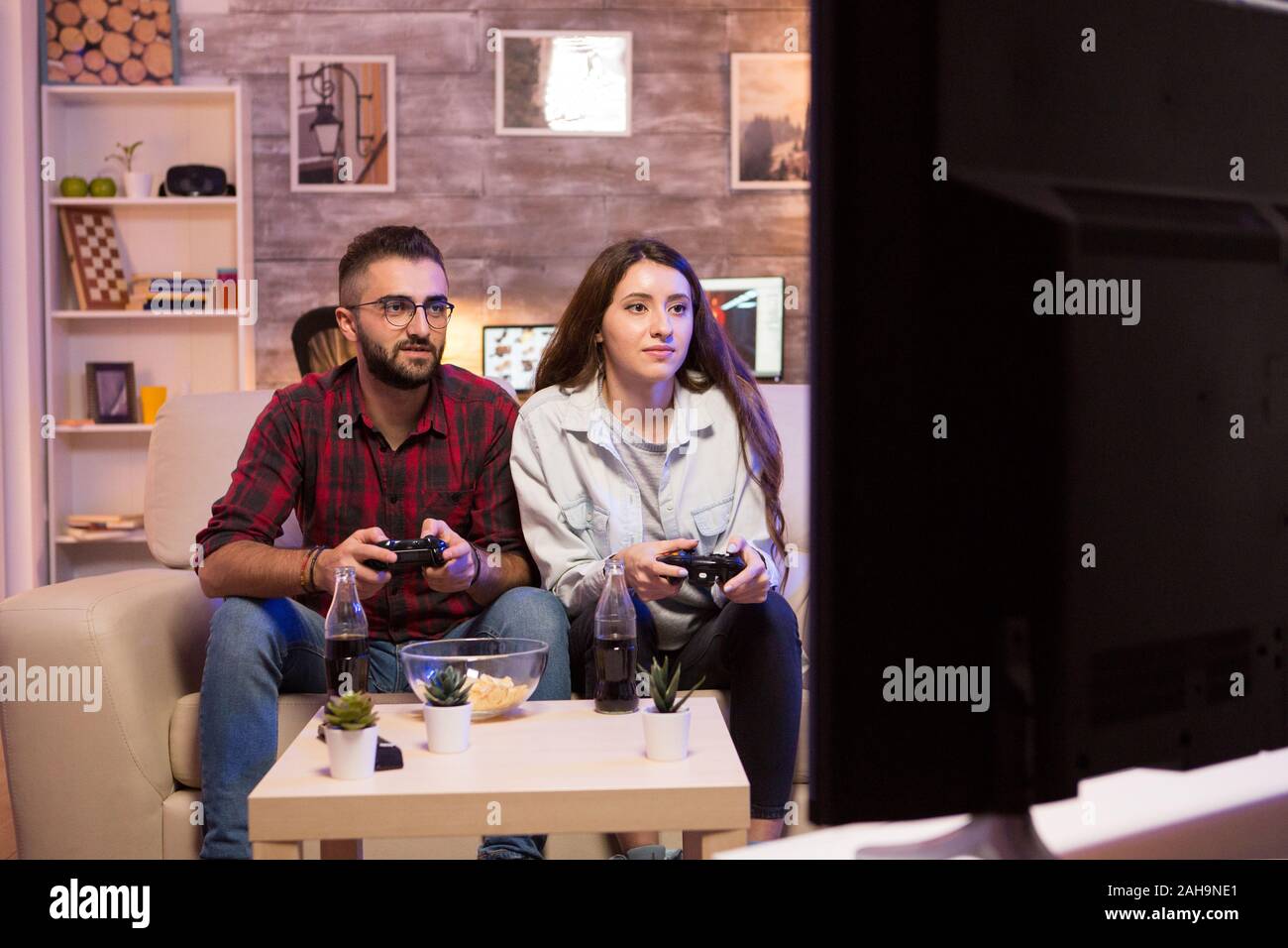 Boyfriend playing video games with his girlfriend on television using ...