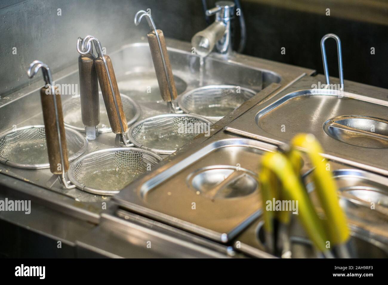 Boilers with noodle baskets and hot hold containers in a restaurant ...