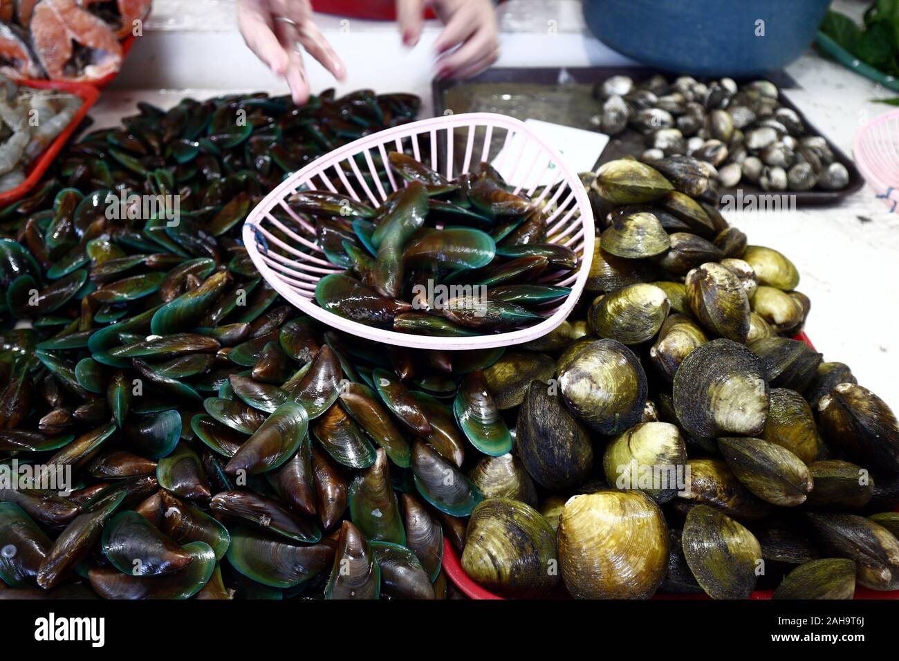Photo of a bunch of fresh and raw shell fish sold at a public market ...