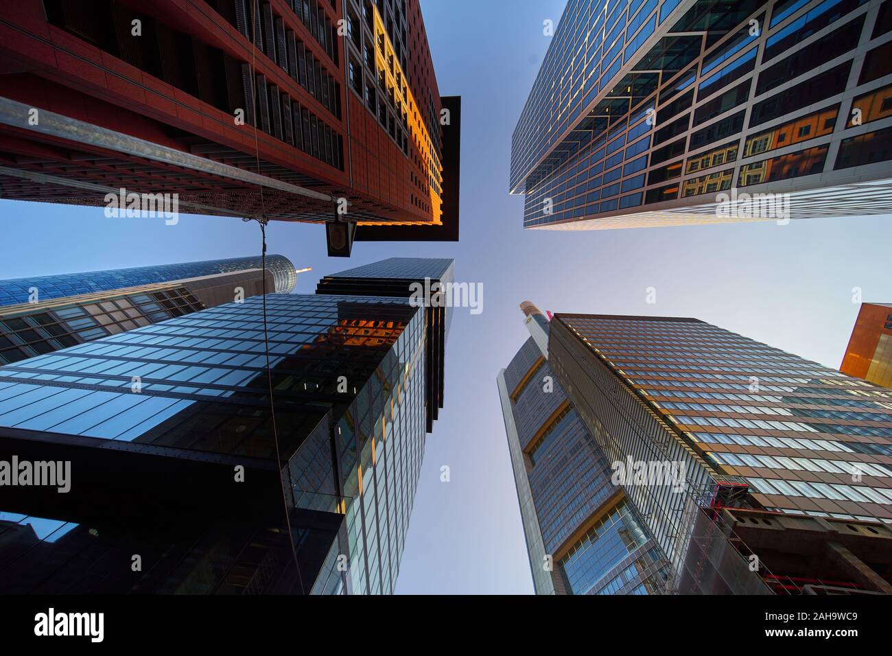 View of the small piece of free blue sky between four towers of high ...