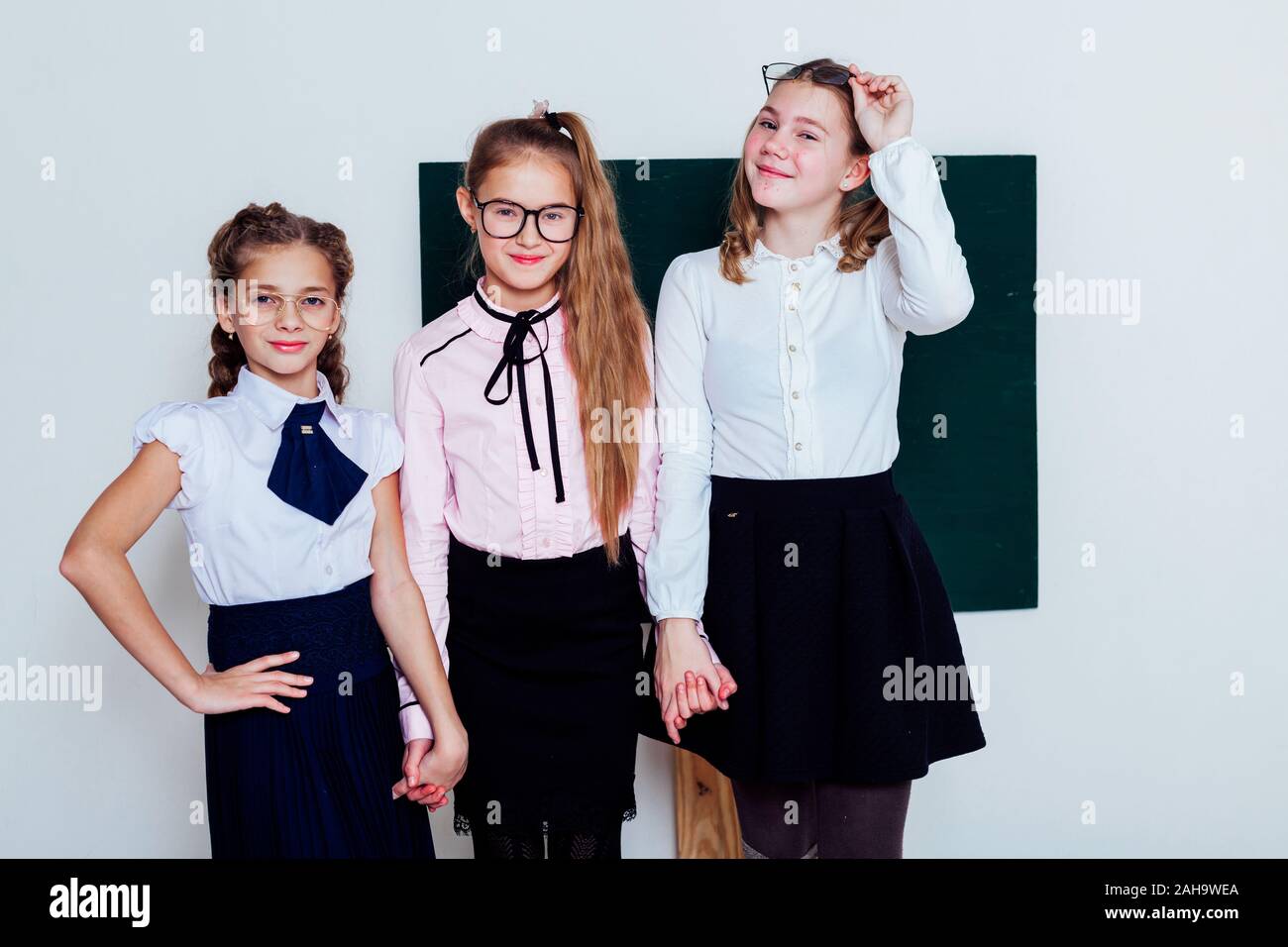 three girls in glasses at the Blackboard in a class lesson Stock Photo ...
