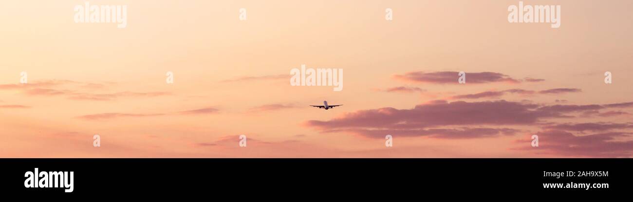 Sunset sky with taking off plane, banner format Stock Photo - Alamy