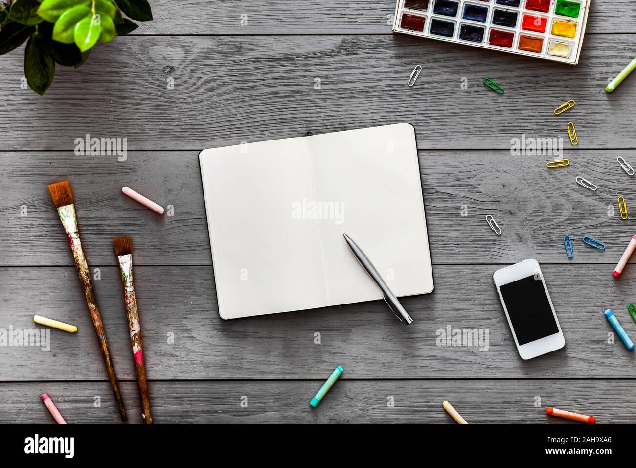 Creative art table background with notebook paints, drawing education ...