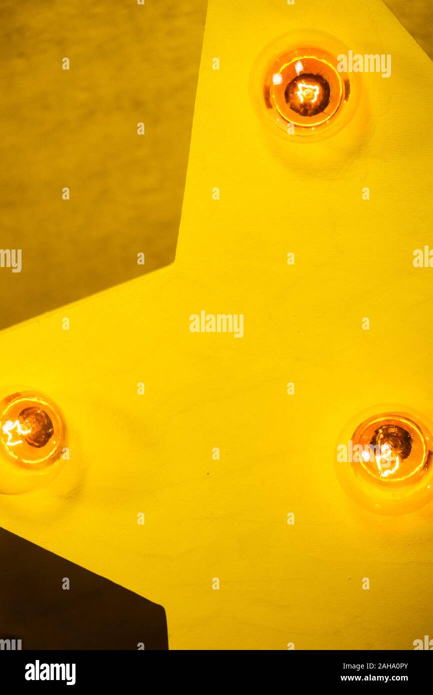 Wooden yellow star with bulb lights lit on it christmas background ...