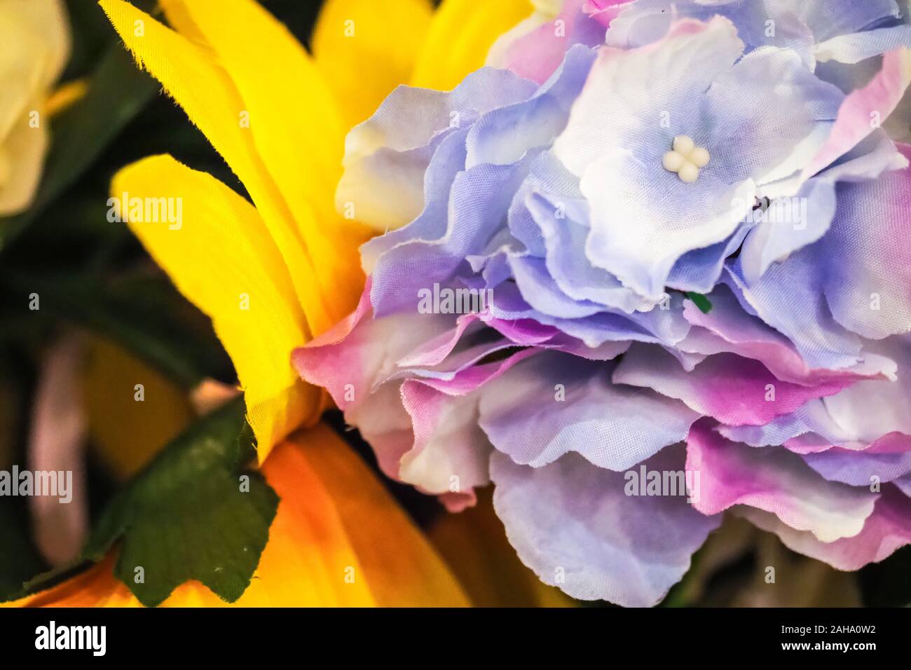 Colorful silk artificial flowers background Stock Photo - Alamy