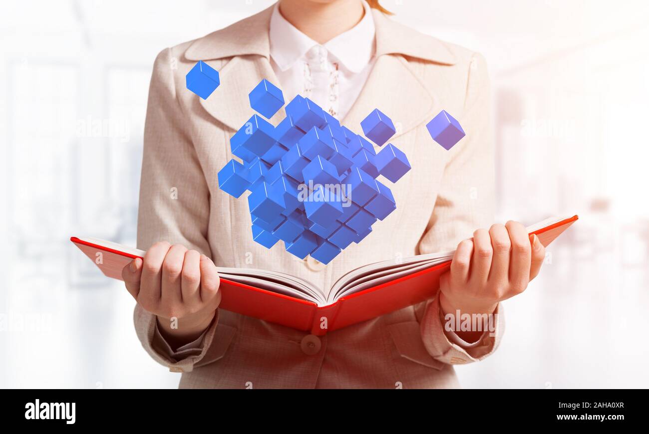 Young woman holding open book with flying 3d blue cubes. Hi-tech ...