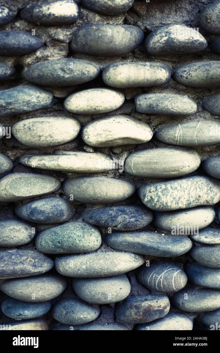 Stone wall of pebbles with concrete in garden background Stock Photo ...