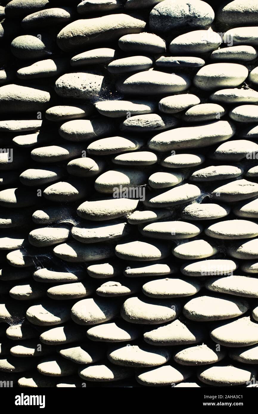 Stone wall of pebbles with concrete in garden background Stock Photo ...