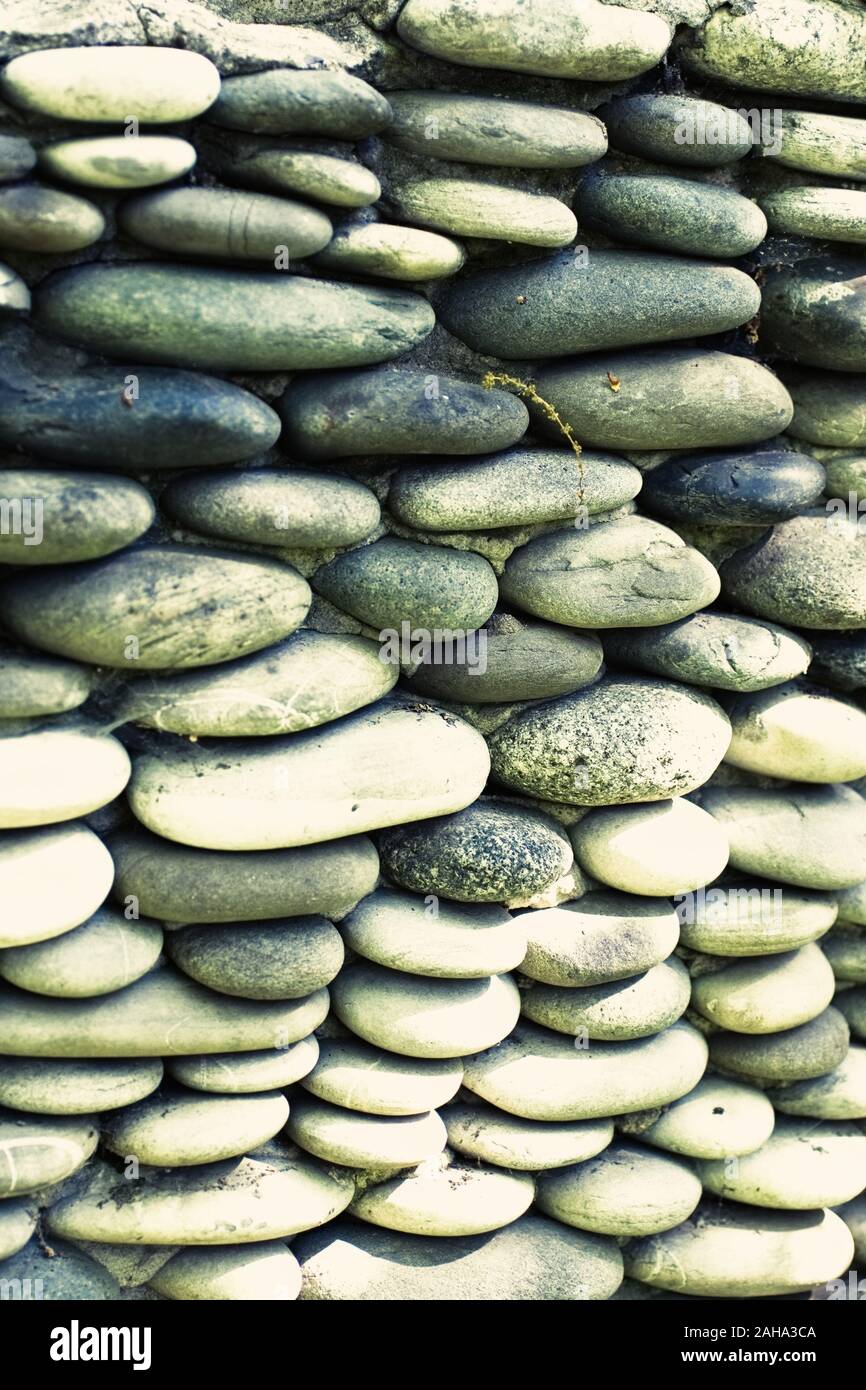 Stone wall of pebbles with concrete in garden background Stock Photo ...