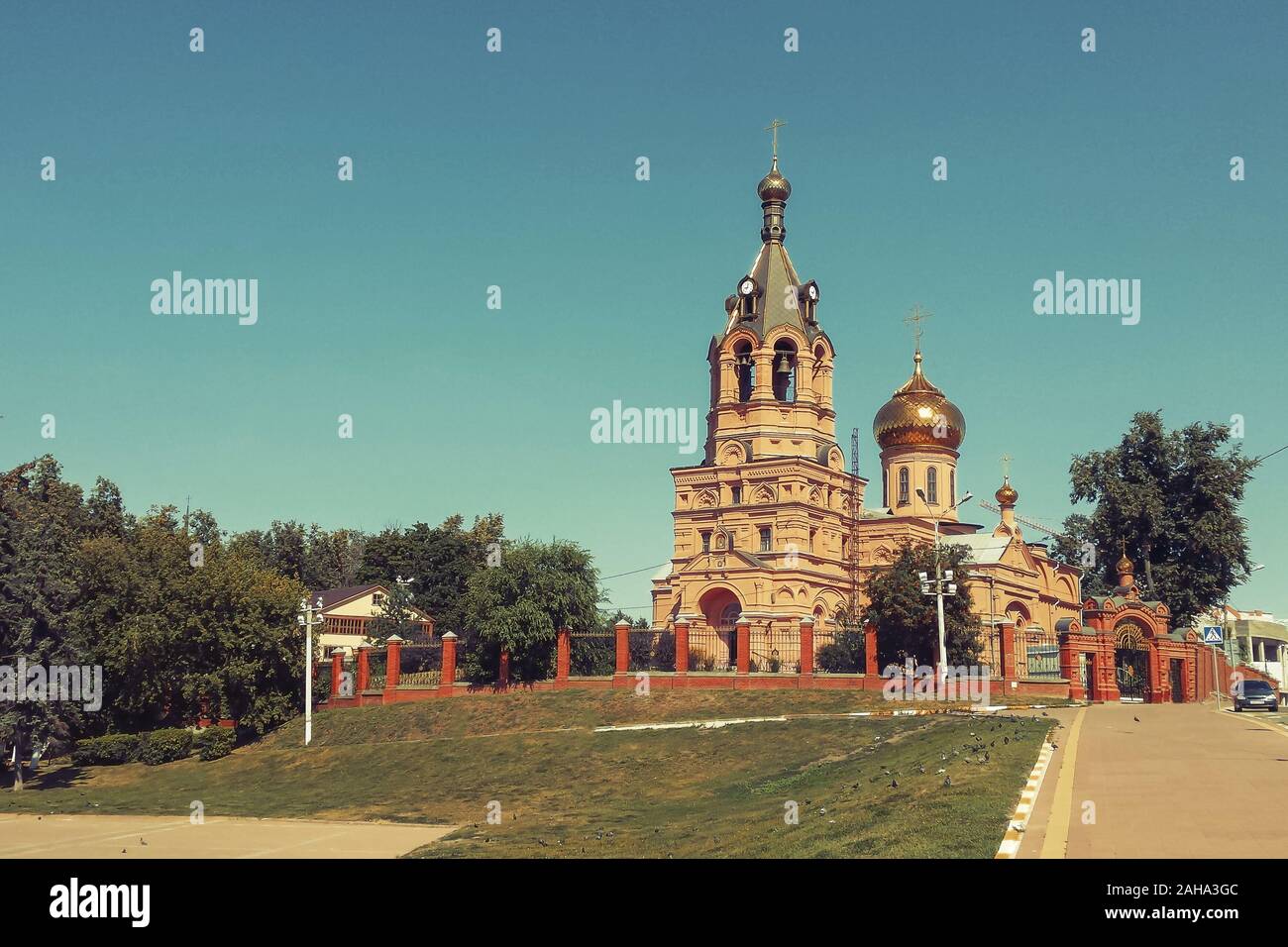 Orthodox red church architecture in green park in Russia background ...