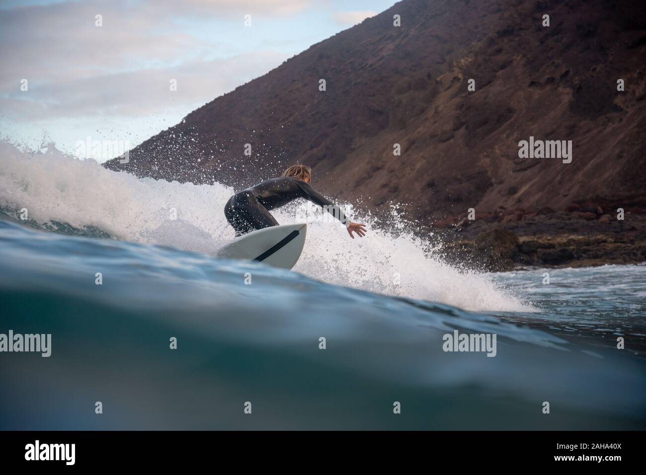 surfer riding waves on the island of fuerteventura Stock Photo - Alamy