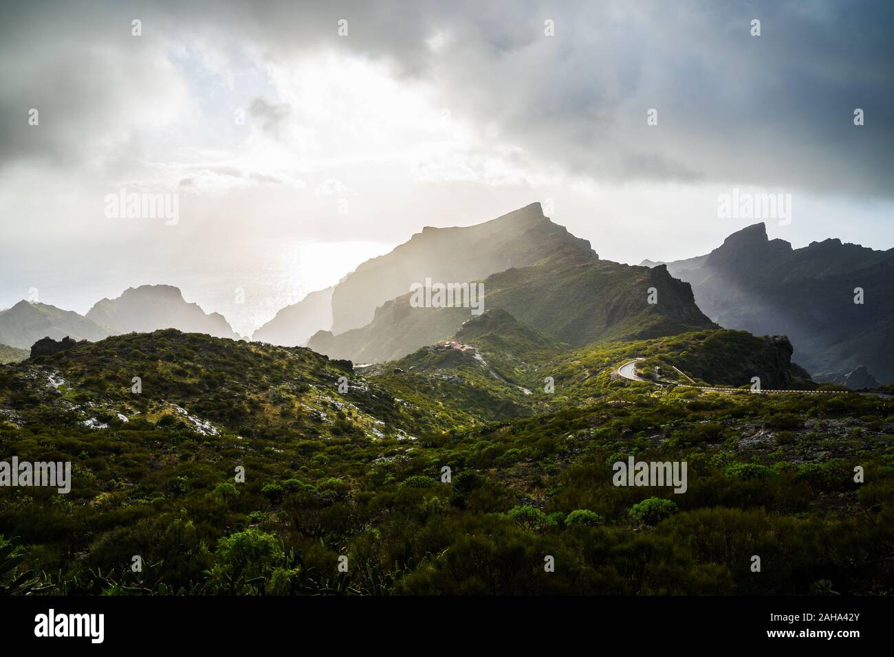 Spain, Tenerife, Dark rain clouds on stormy day with sun over mountains ...
