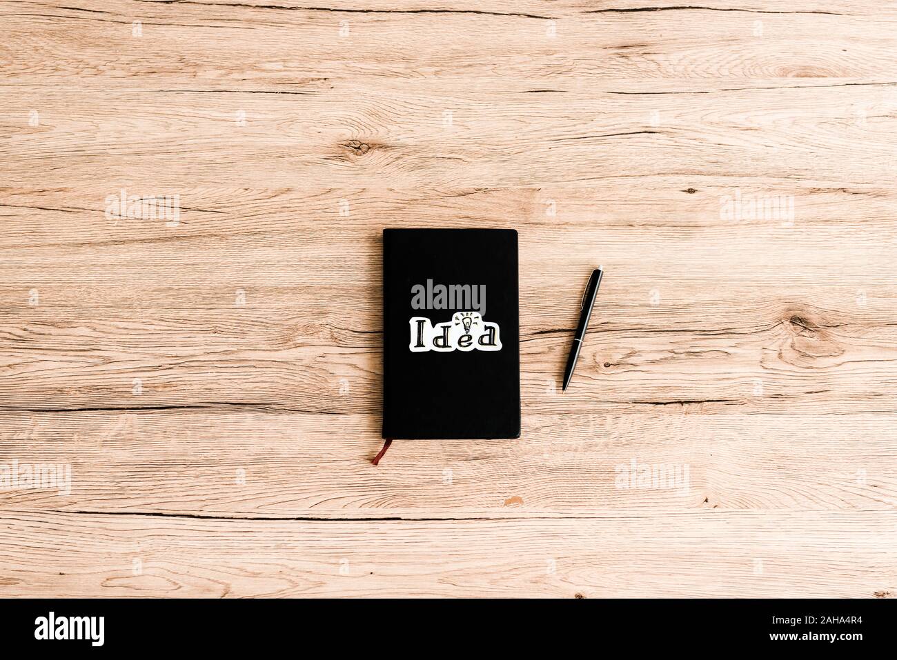 top view of paper with idea lettering on black notebook with pen Stock ...