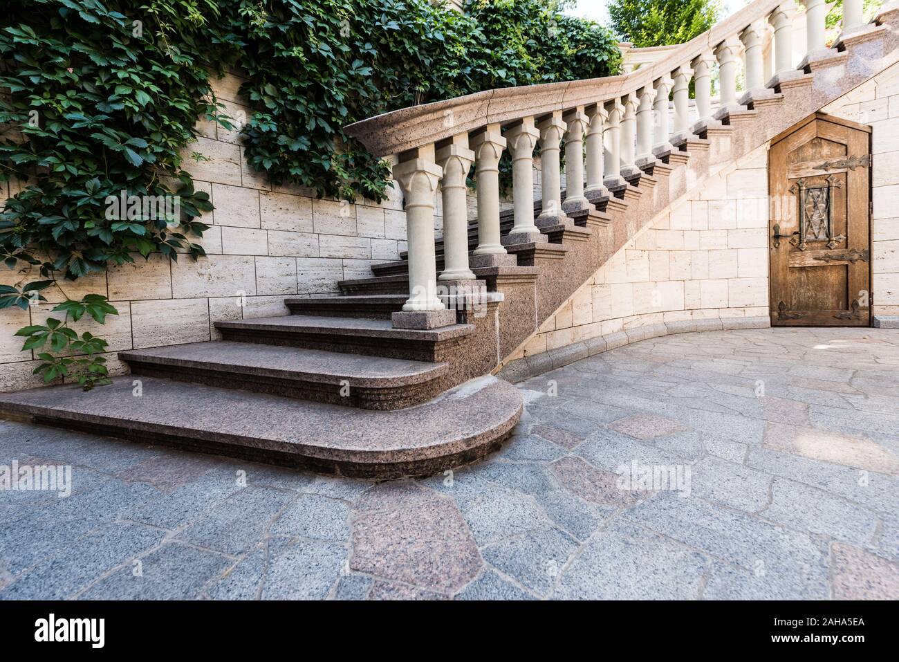 white concrete stairs near green and fresh leaves on wall Stock Photo ...