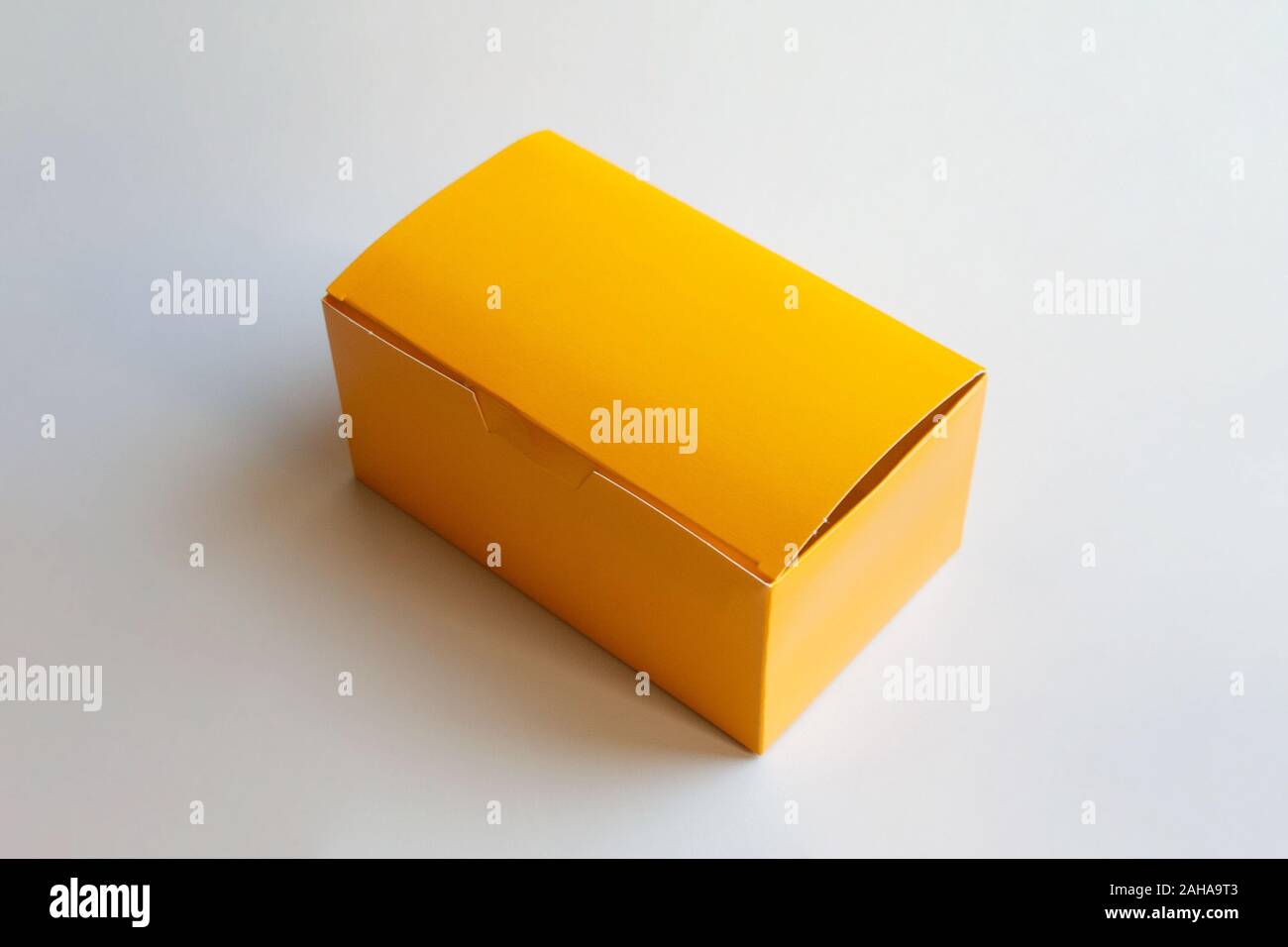 Yellow paper box container isolated on white background Stock Photo - Alamy