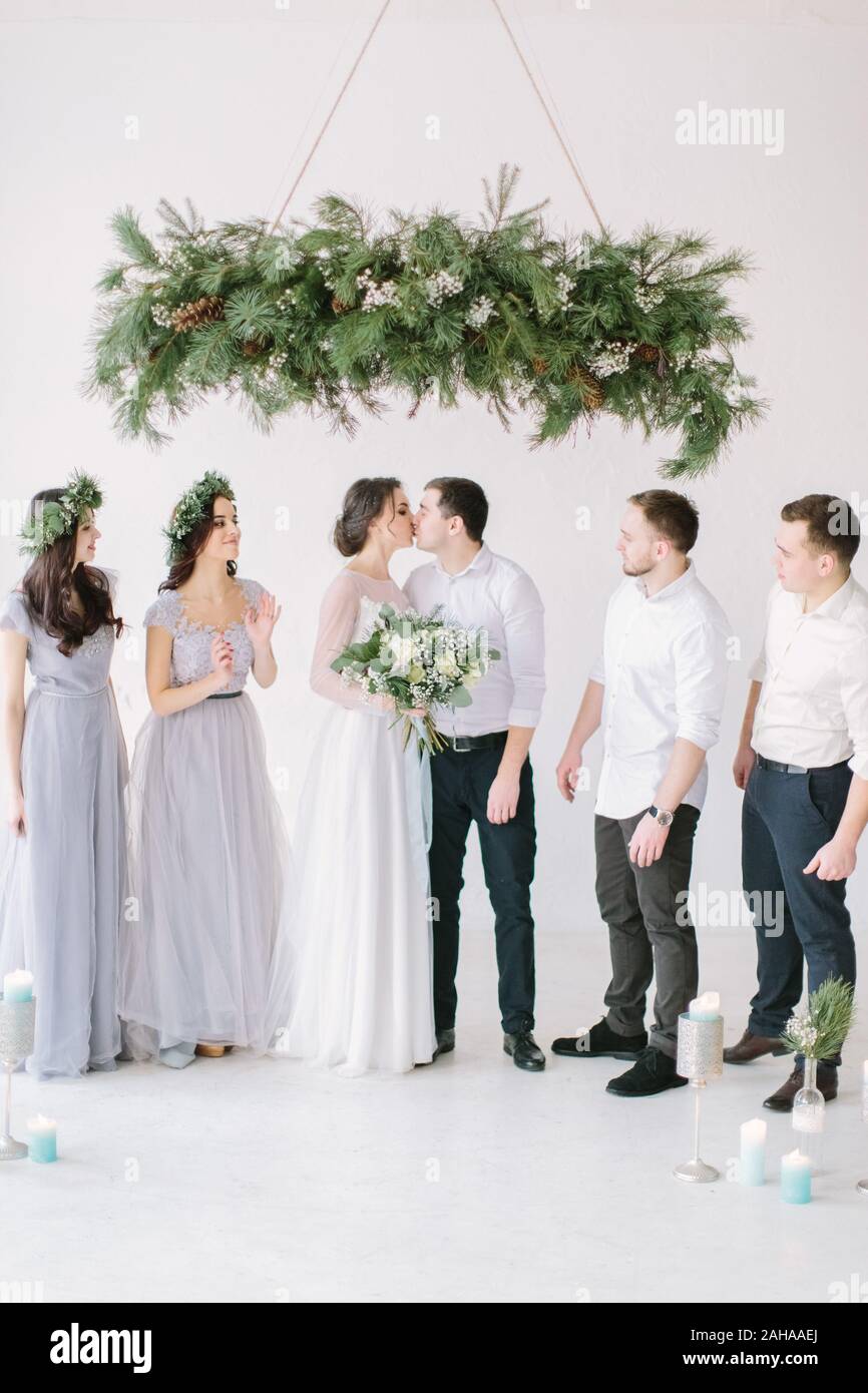 Full length portrait of newlywed couple and their friends at the ...