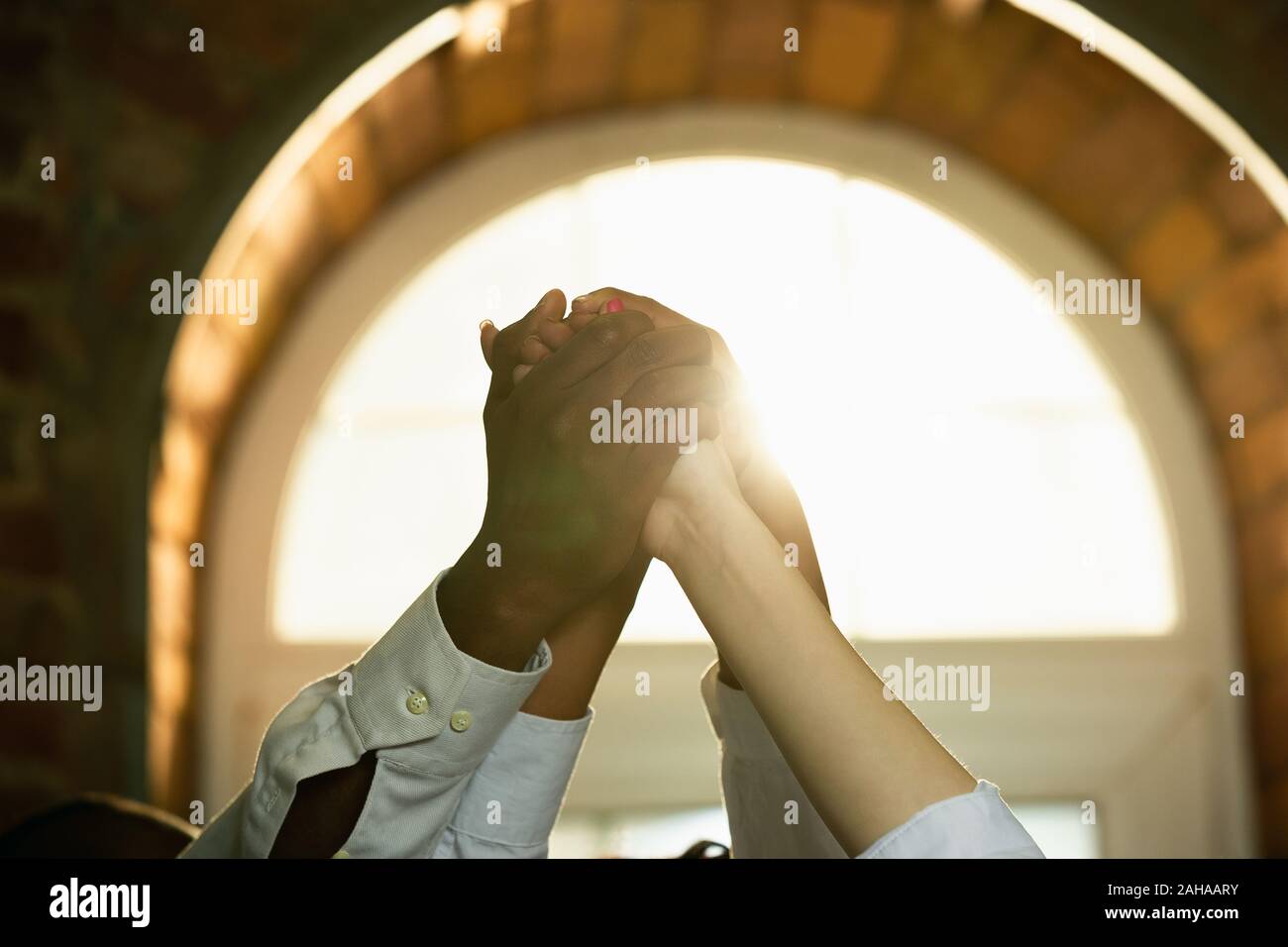 Close up of african-american and caucasian human's hands holding ...