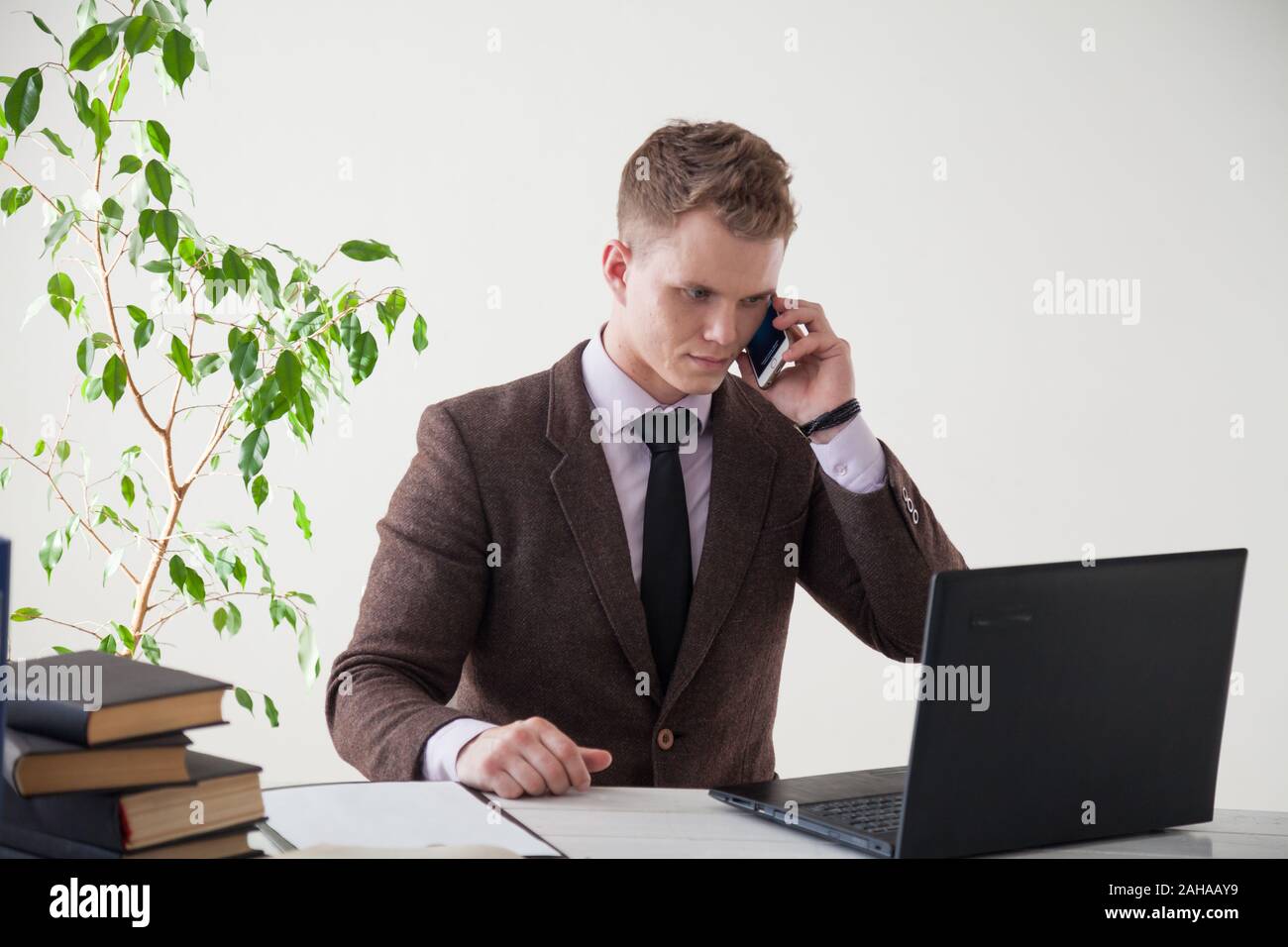 portrait of a beautiful fashionable strong man in a business suit at ...
