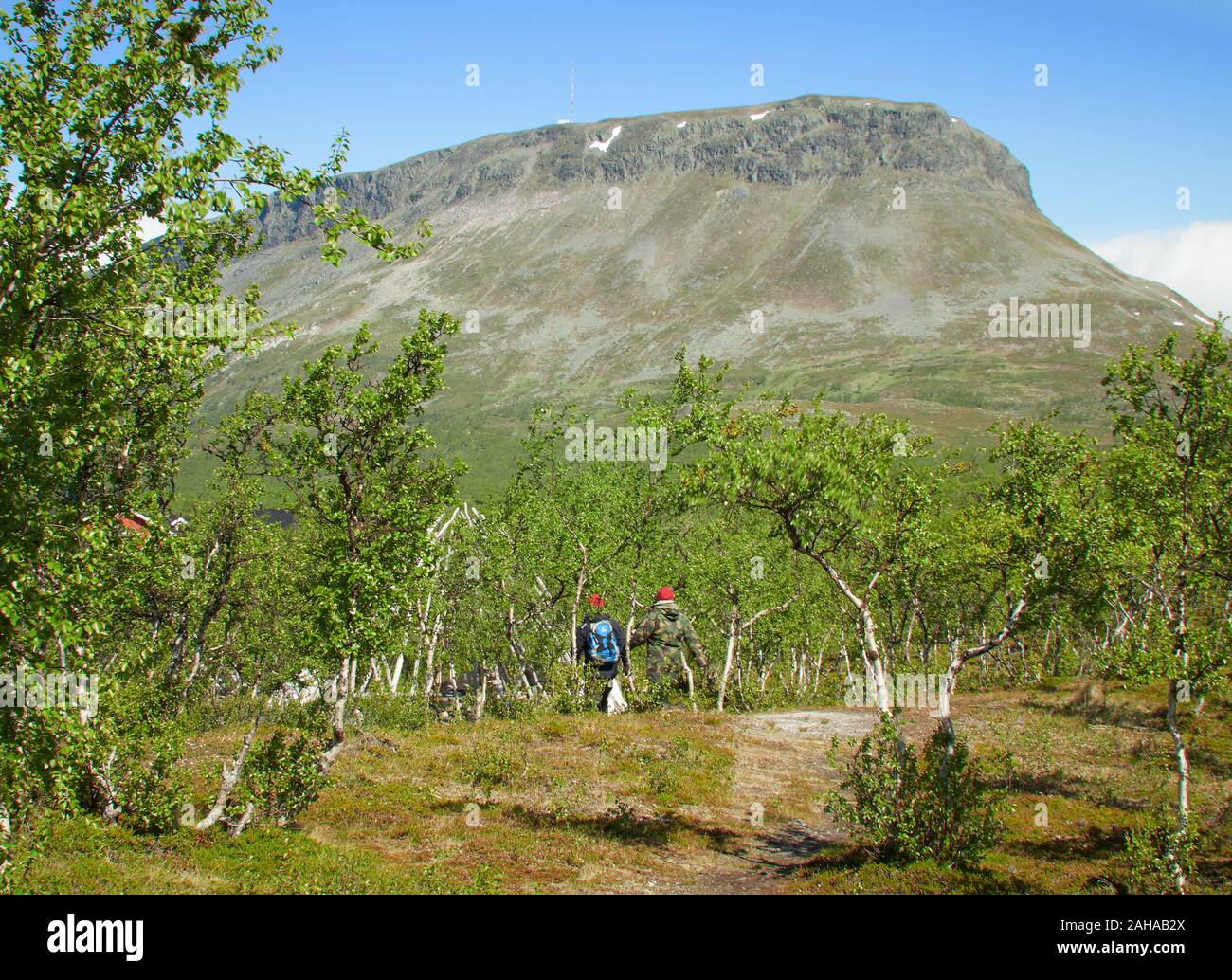 Two hikers going to the Saana fells in Kilpisjarvi, Finnish Lapland ...