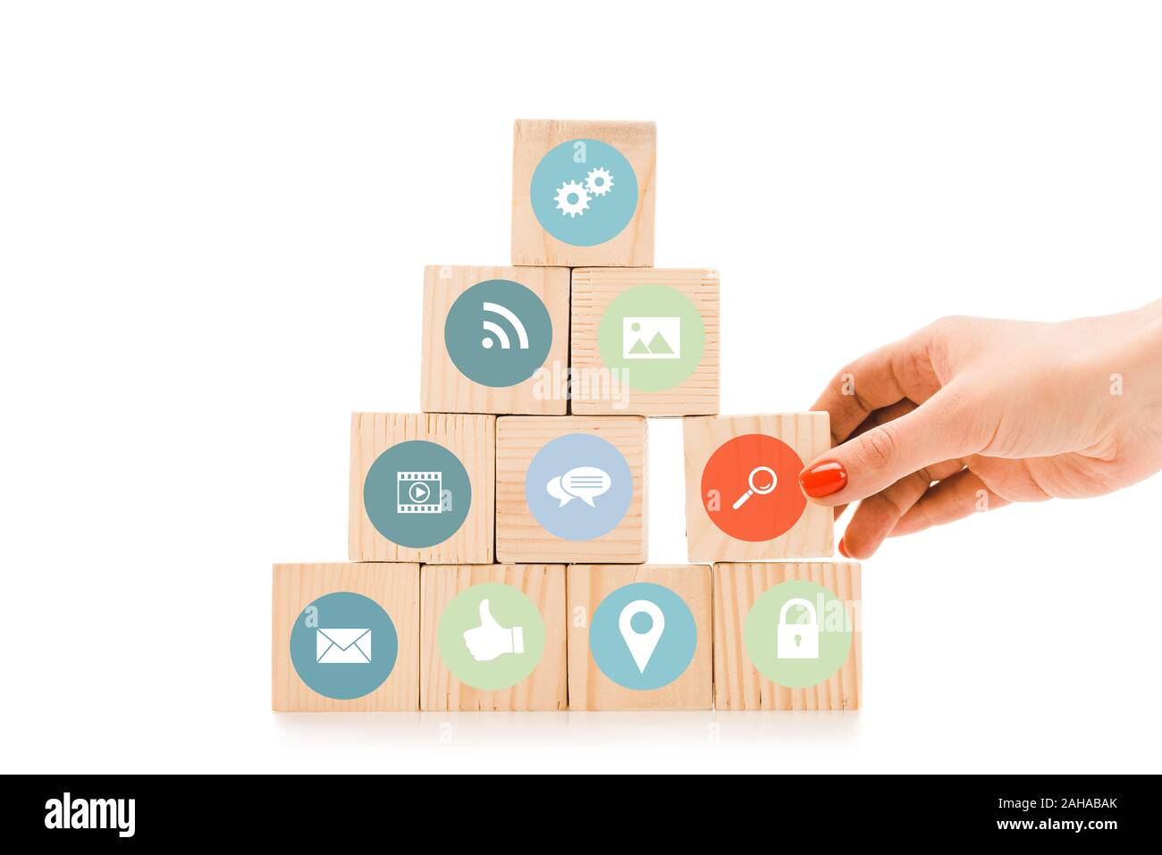 partial view of woman picking up wooden block with red magnifier sign ...