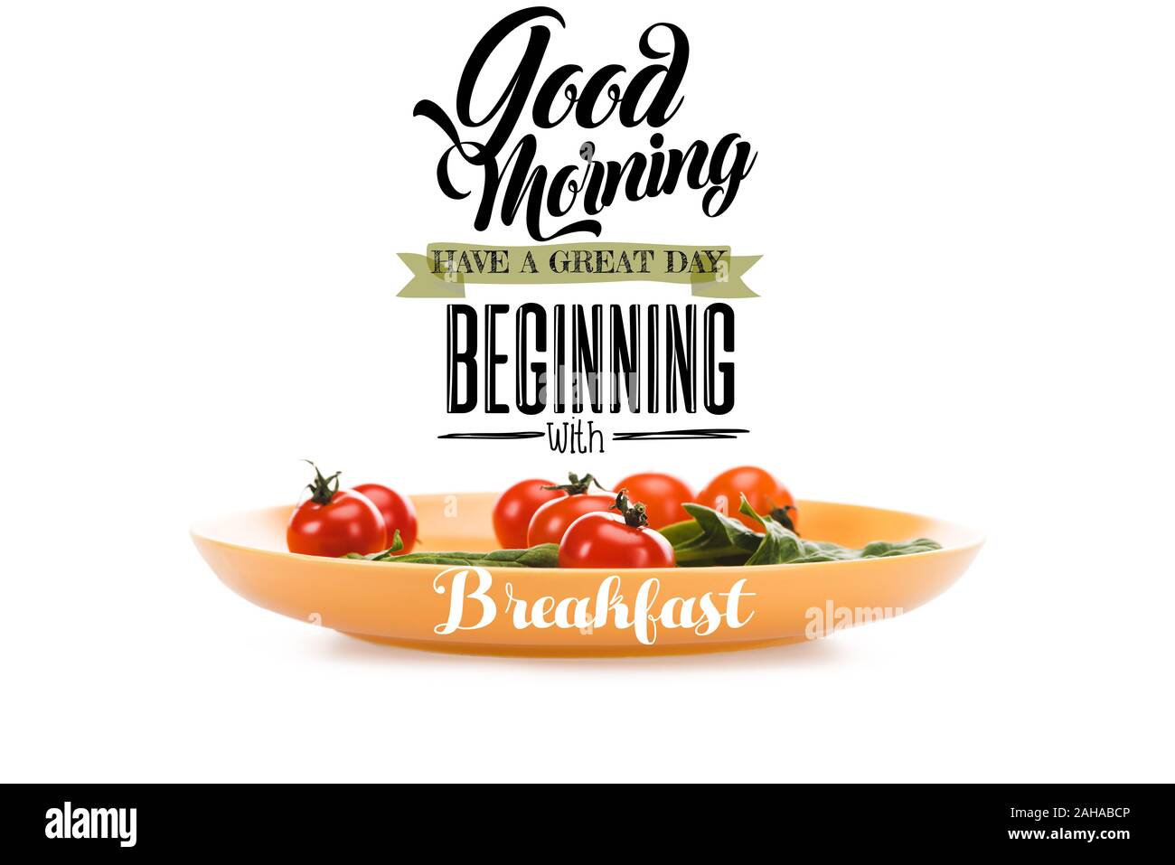 cherry tomatoes with green spinach leaves in yellow plate with good ...