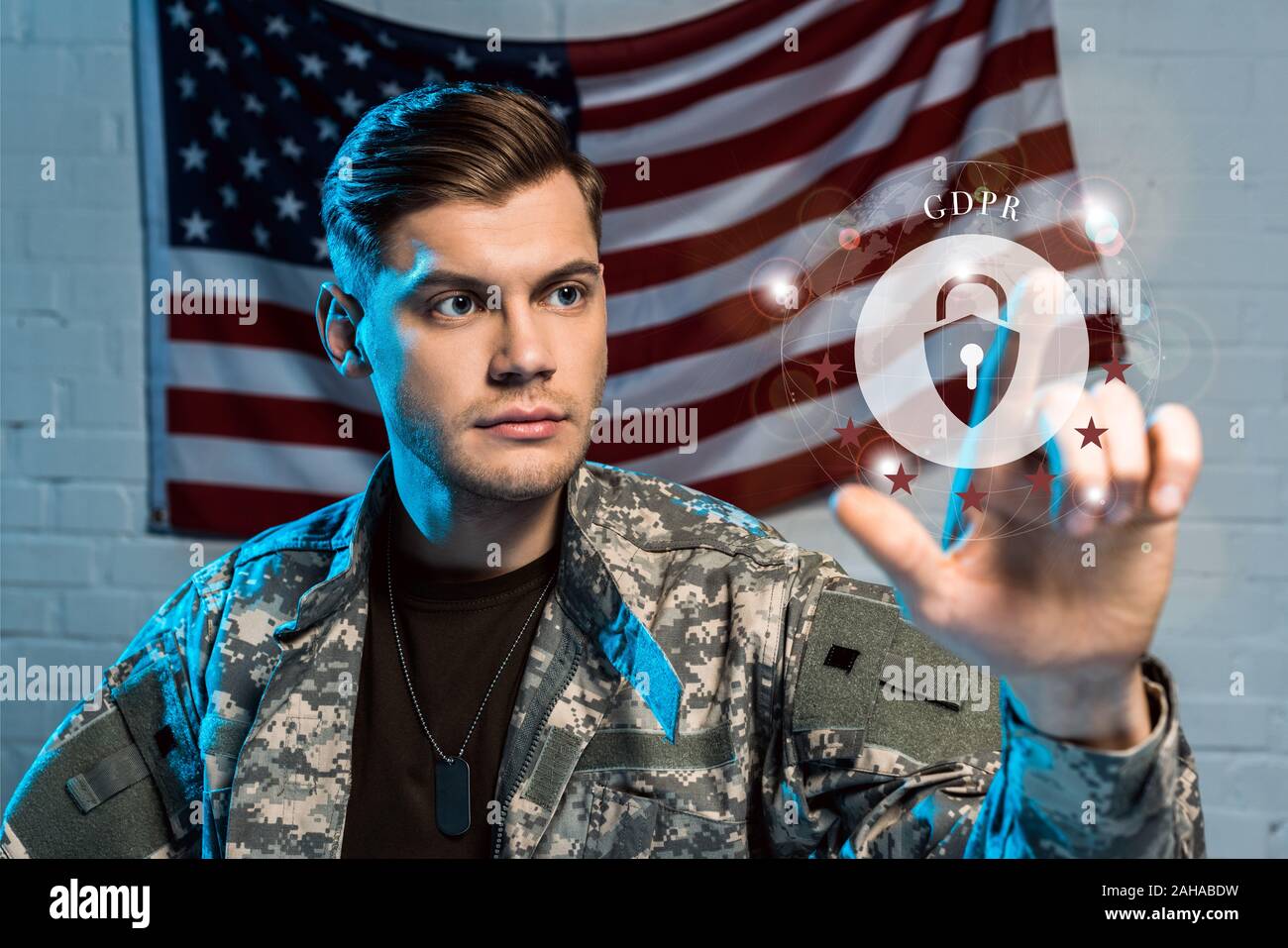 selective focus of handsome soldier pointing with finger at padlock ...