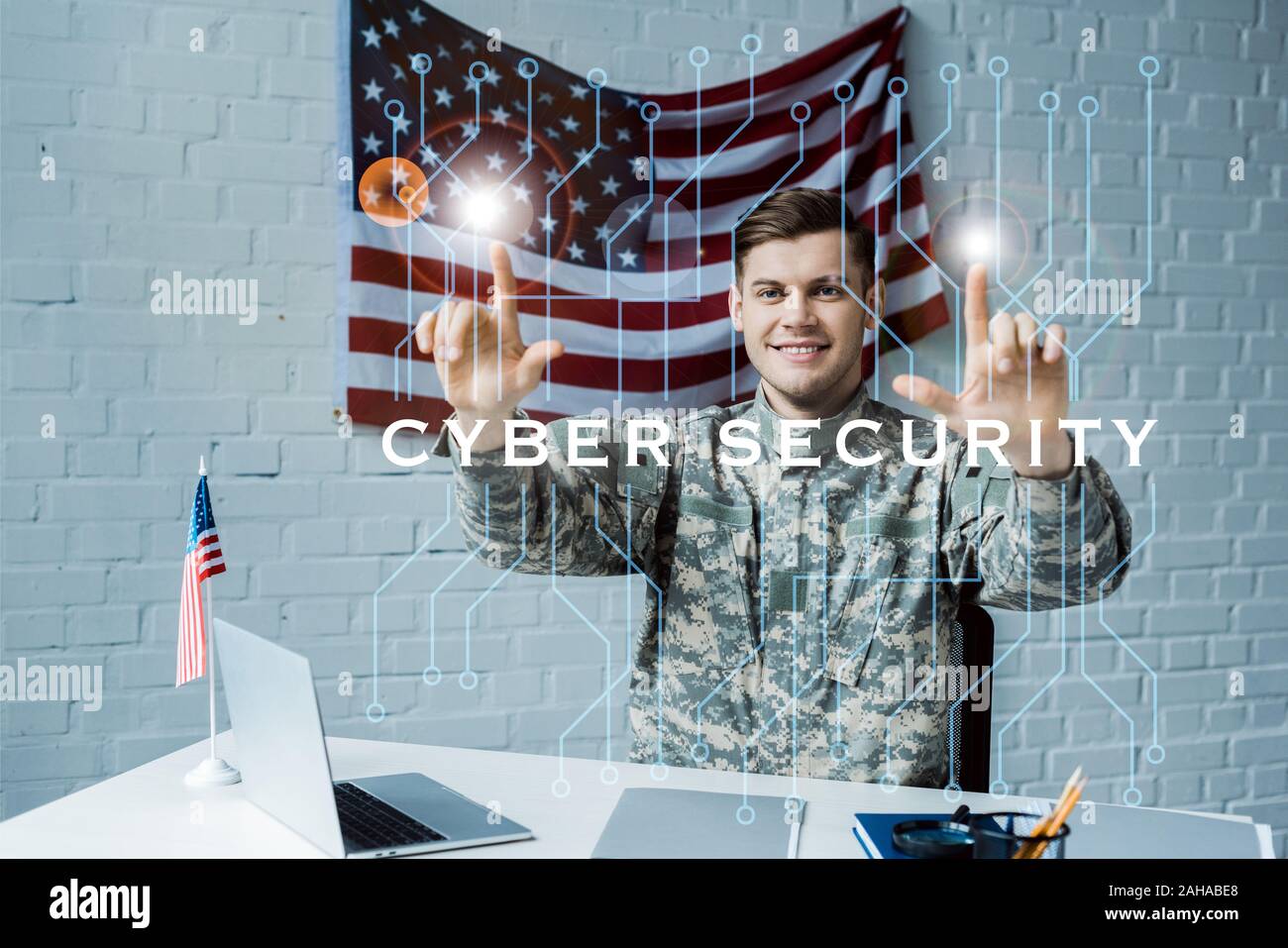 cheerful man in military uniform pointing with fingers at cyber ...