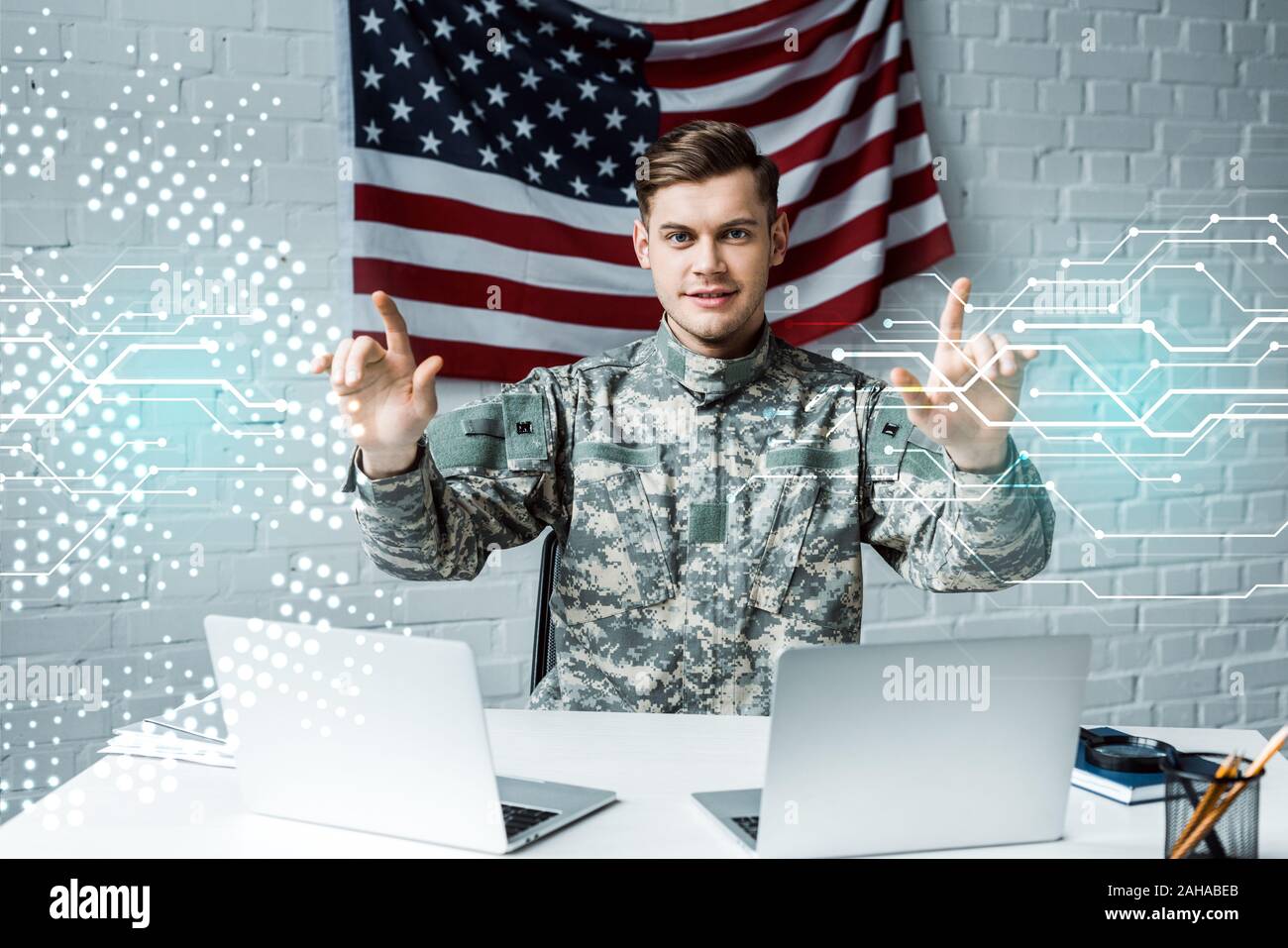cheerful man in military uniform pointing with fingers at data ...