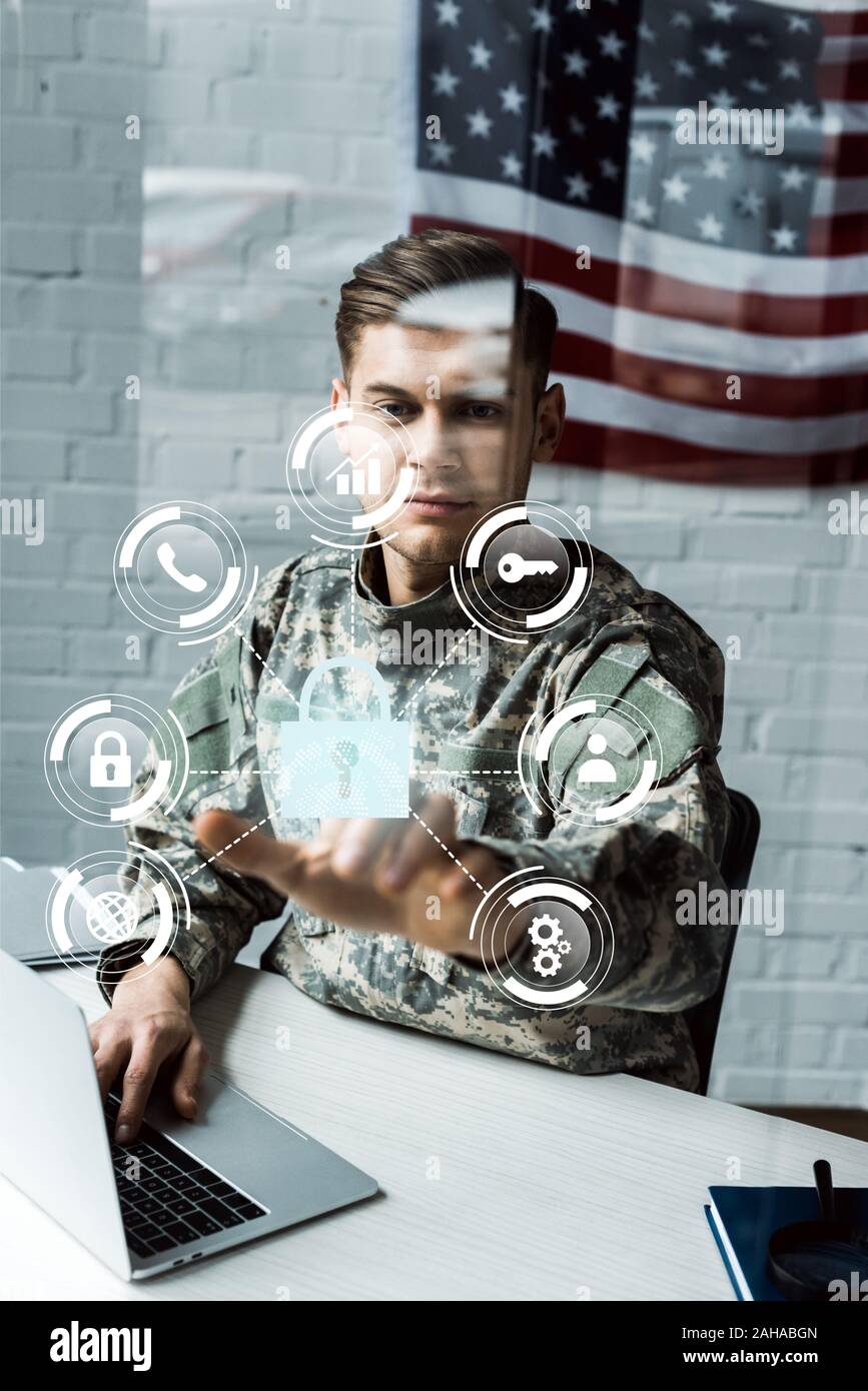 handsome soldier in military uniform pointing with finger at virtual ...