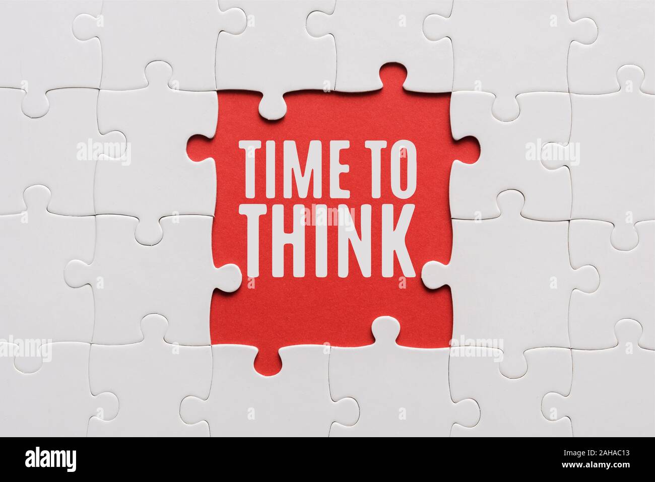 top view of connected jigsaw puzzle pieces near time to think letters ...