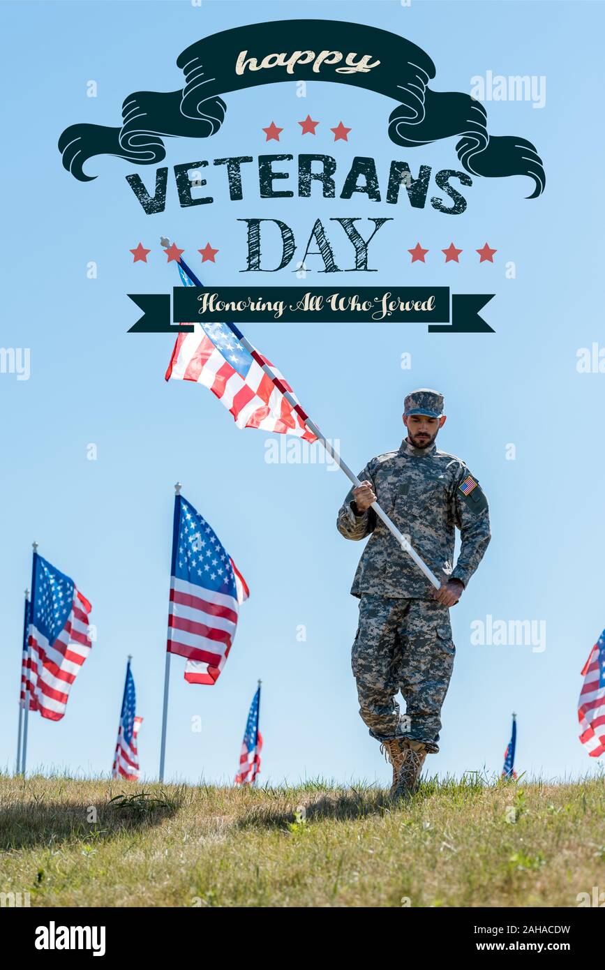 handsome soldier in military uniform and cap holding american flag with ...