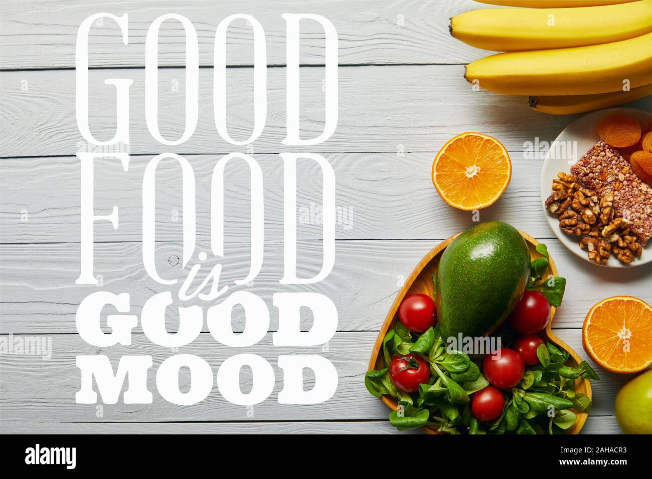 top view of fresh fruits, vegetables in heart-shaped bowl on wooden ...