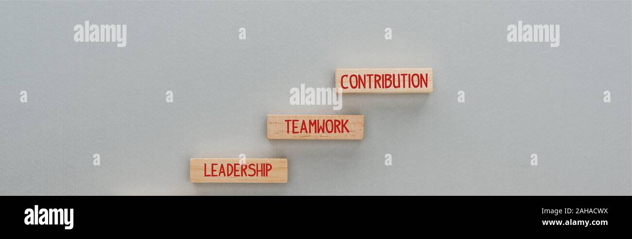 panoramic shot of wooden blocks with leadership, teamwork, contribution ...