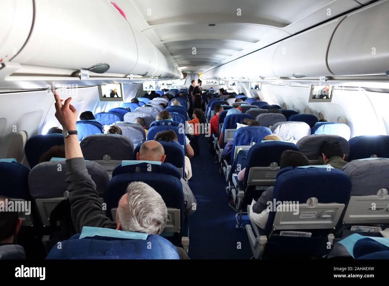 Cramped airplane seat hi-res stock photography and images - Alamy