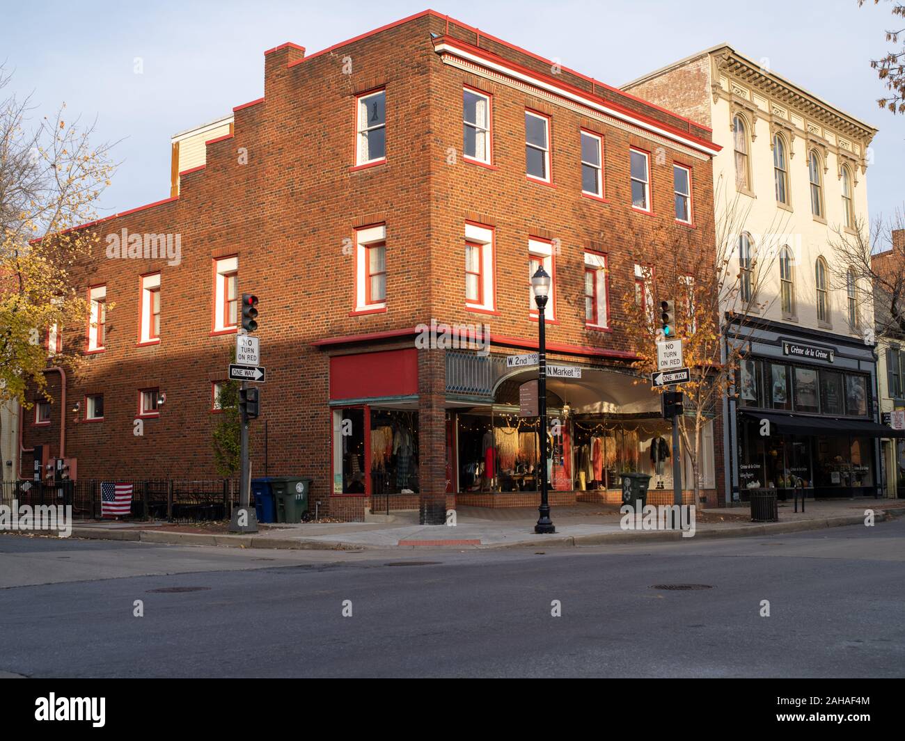 An empty town crossroads with shops and windows in brick buildings ...
