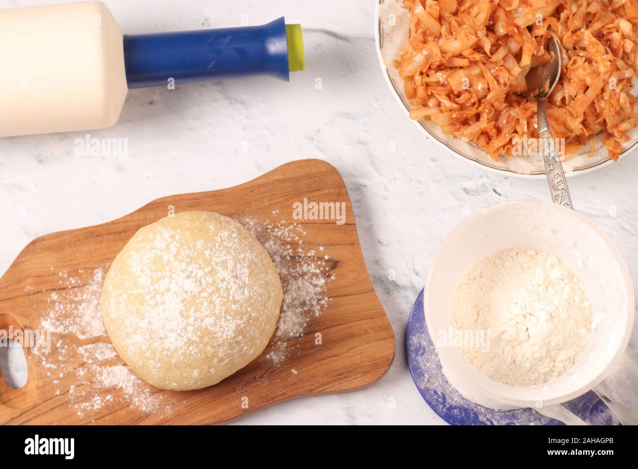 Ingredients for cooking dumplings: dough, fried cabbage and flour ...