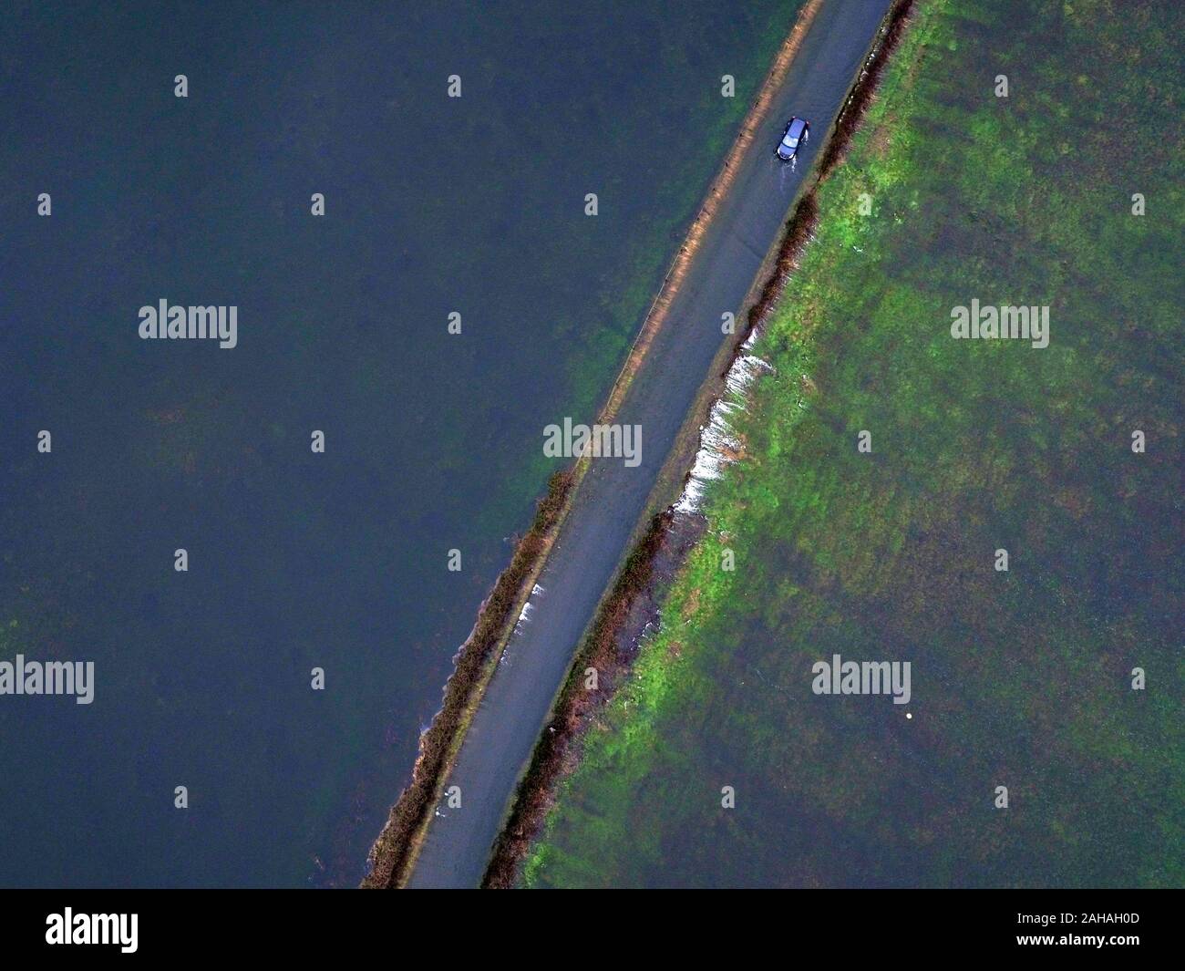A car reverses as it approaches floodwater near Harbridge, 2.5 miles ...