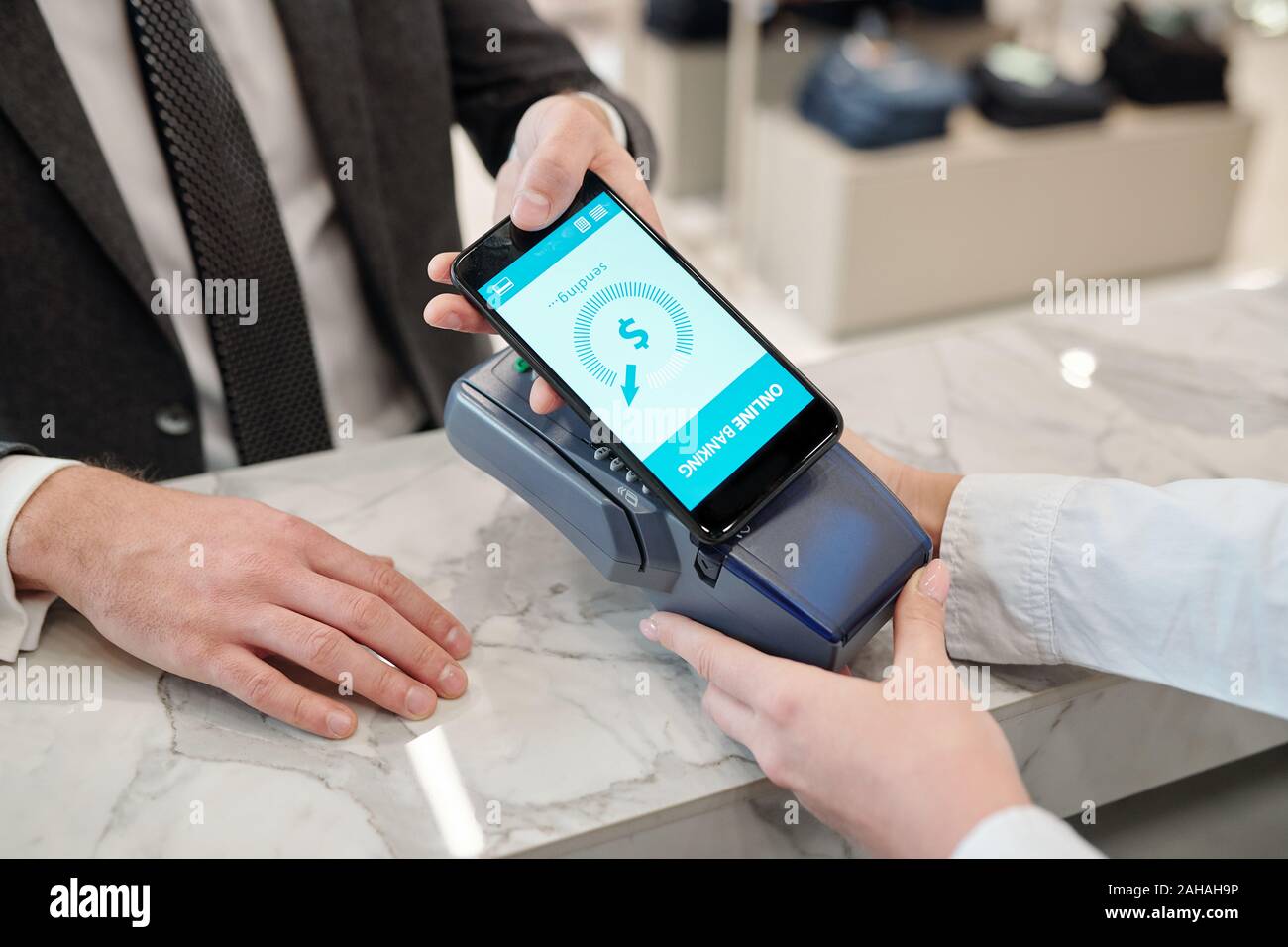 Hands of young mobile man with smartphone during contactless payment ...