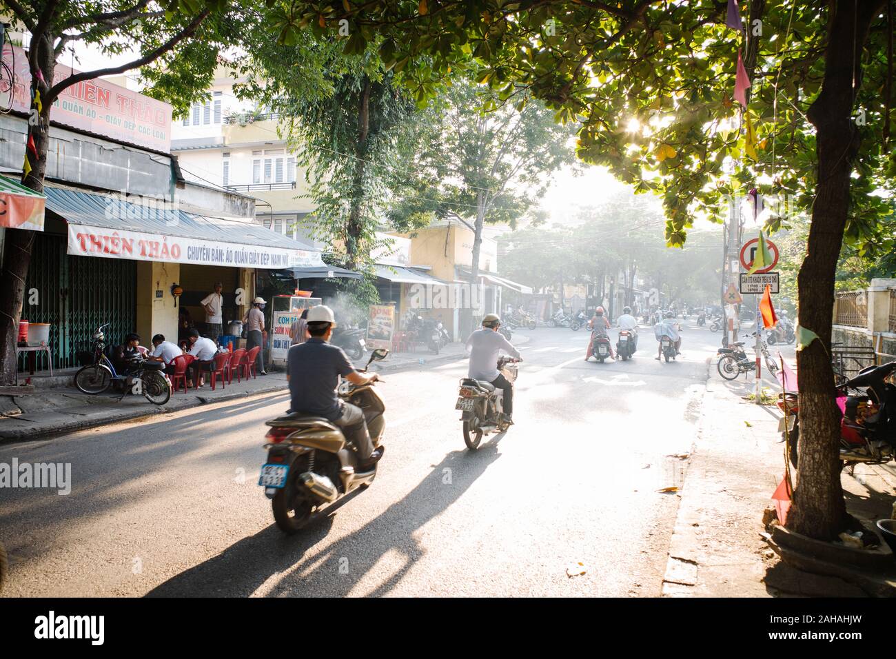 Vietnamese commuters are riding their motorcycles to work early in the ...