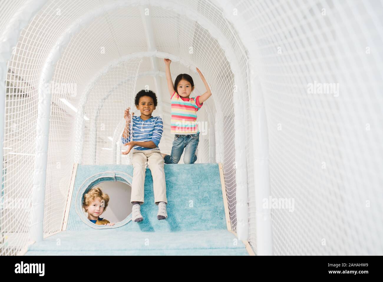 Group of three adorable kids of different ethnicities playing at ...