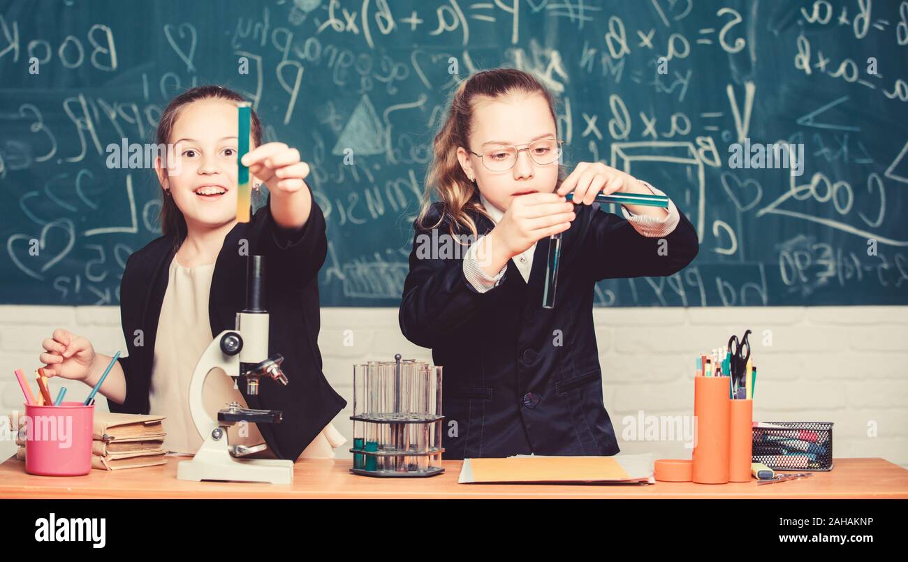 Little scientist work with microscope. Little girls in school lab ...