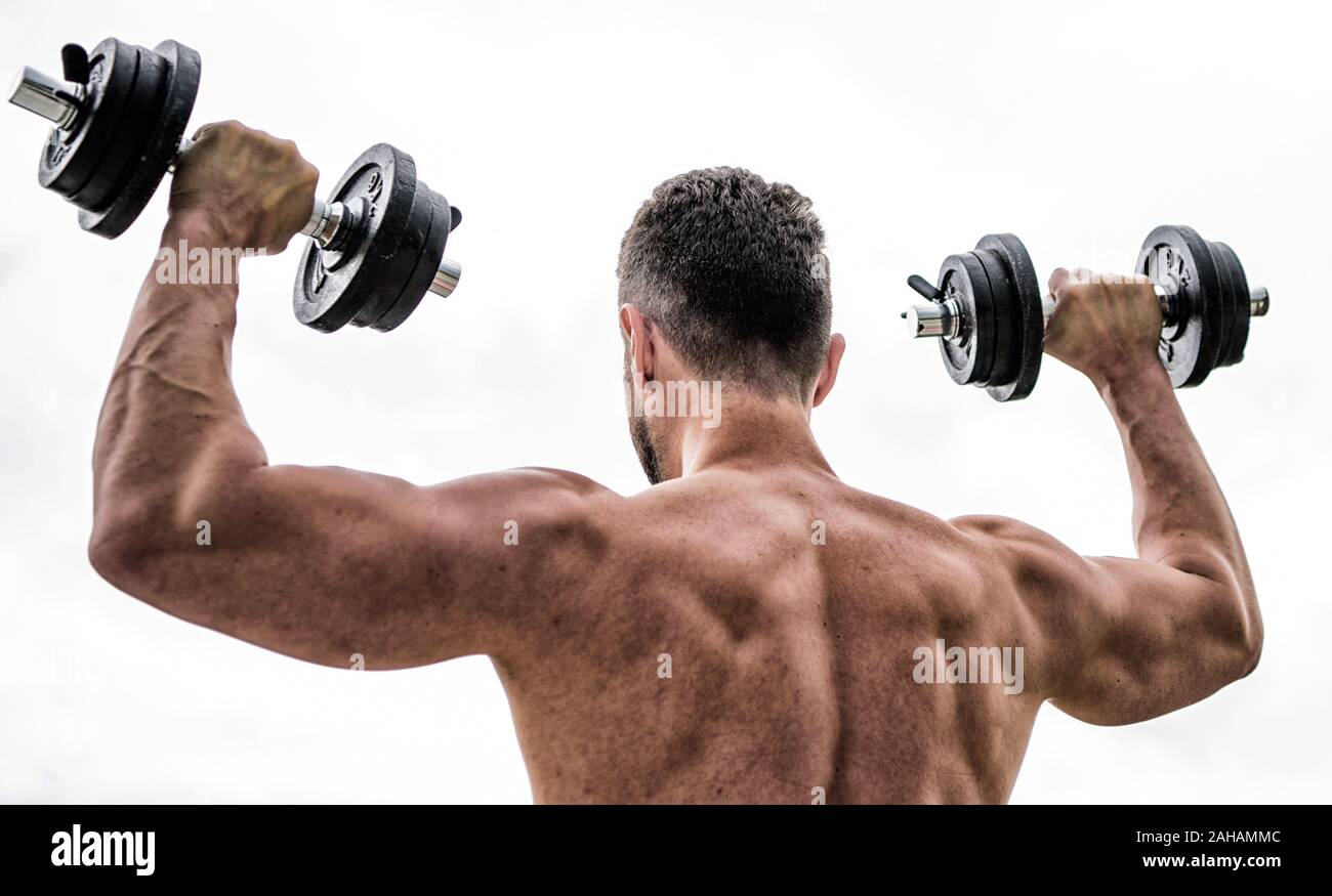 Sportsman with strong back and arms. Sport equipment. Bodybuilding ...