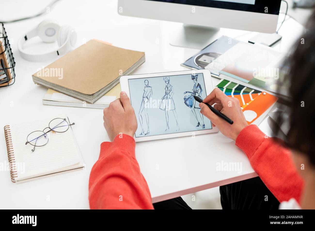 Hands of creative fashion designer choosing new models for seasonal ...