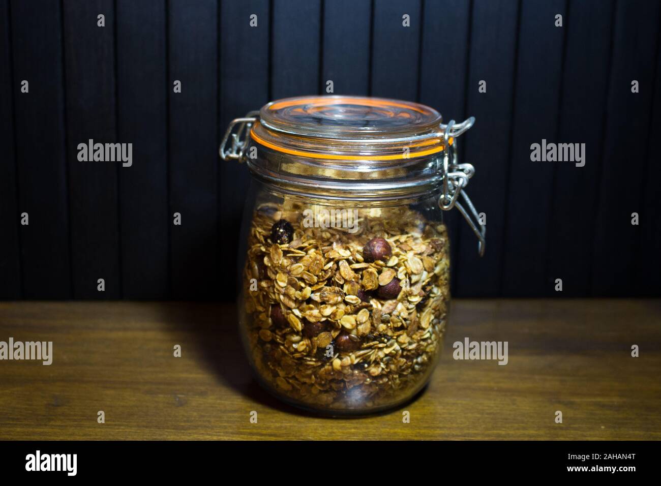 Jar with granola, muesli. Homemade multigrain granola with a nuts in a ...