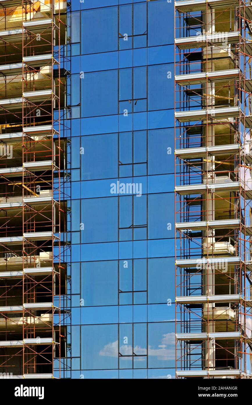 Scaffoldings at building with blue windows during construction Stock ...