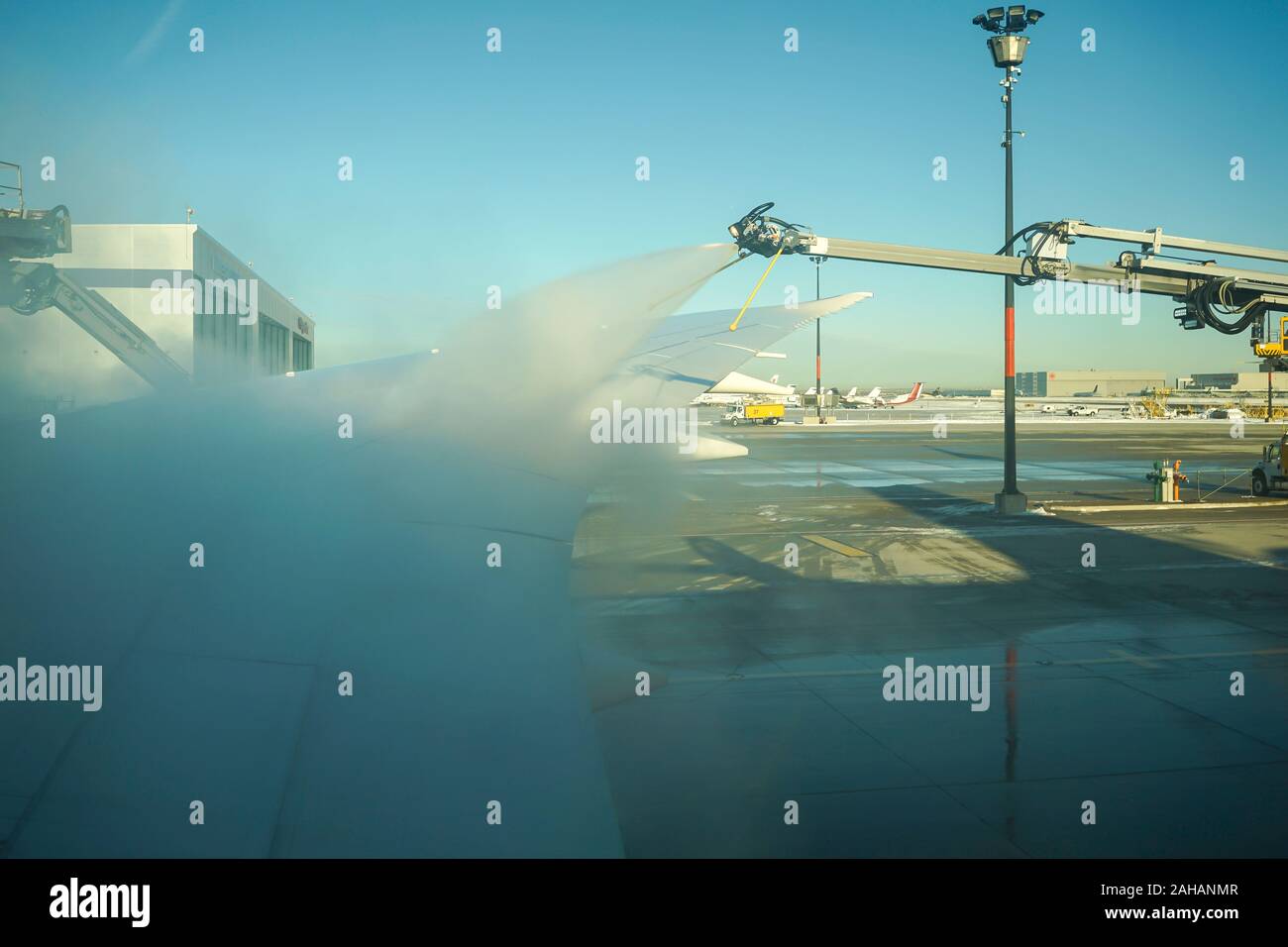 Boeing 737 wing worker is de-icing a commercial airliner wing in ...